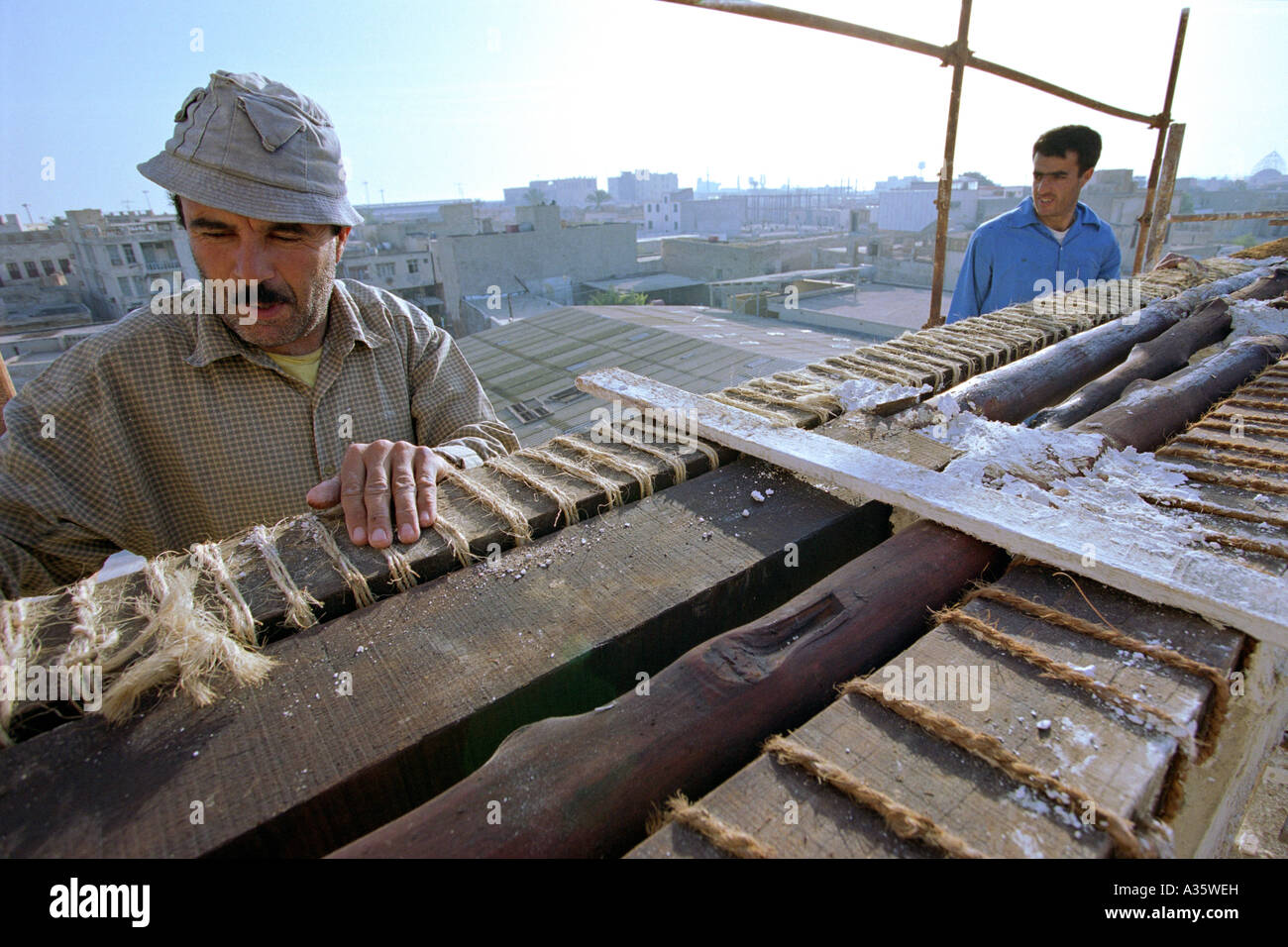 Two men work on the restoration of an old building in Bushehr, Iran ...