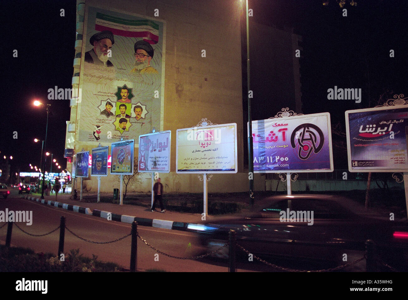 Billboards adorn a night street scene in downtown Tehran, Iran Stock ...