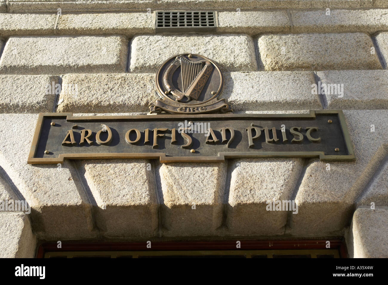 irish language sign ard oifig an poist and harp symbol above the door ...