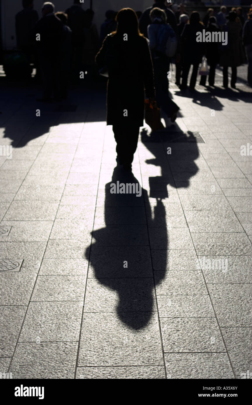 Winter sun woman walking shadow hi-res stock photography and images - Alamy