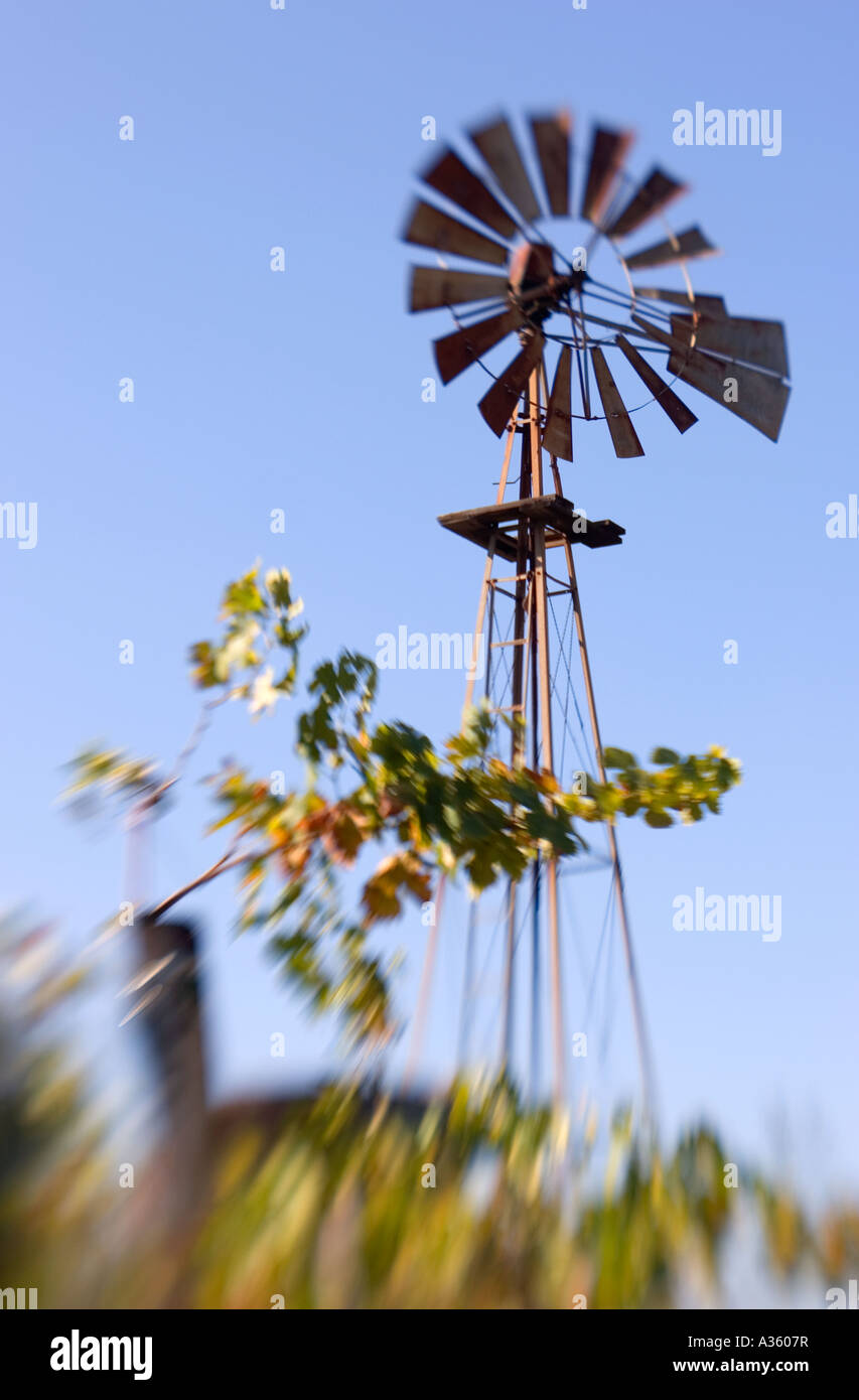 A rustic farm windmill is seen against a clear blue sky Stock Photo - Alamy