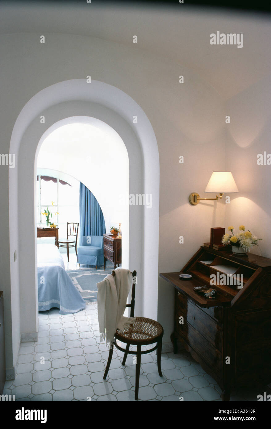 Study area on landing with wall-lamp above desk and Thonet chair beside ...