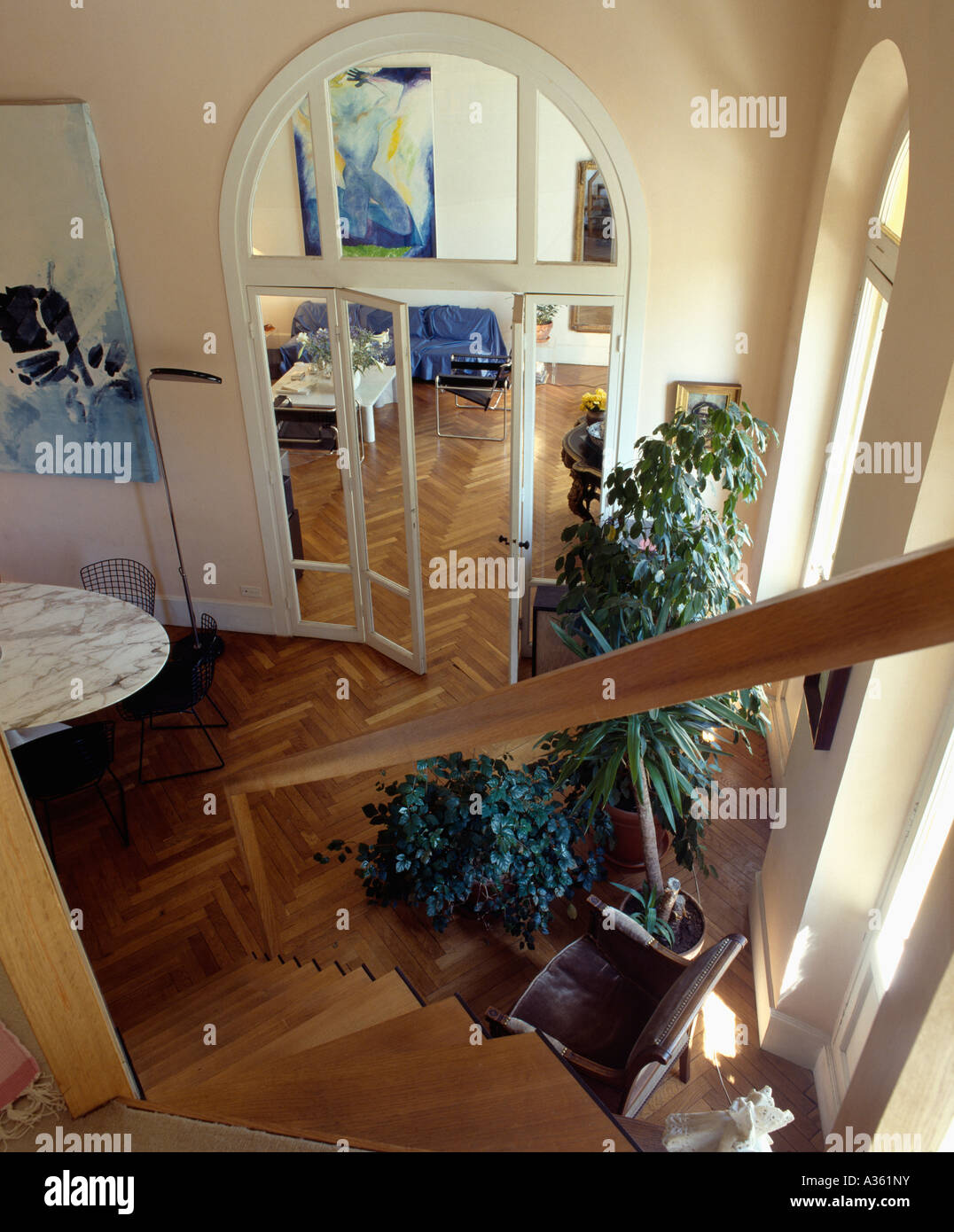 Birdseye view of staircase and arched doorway with glass door in hall ...