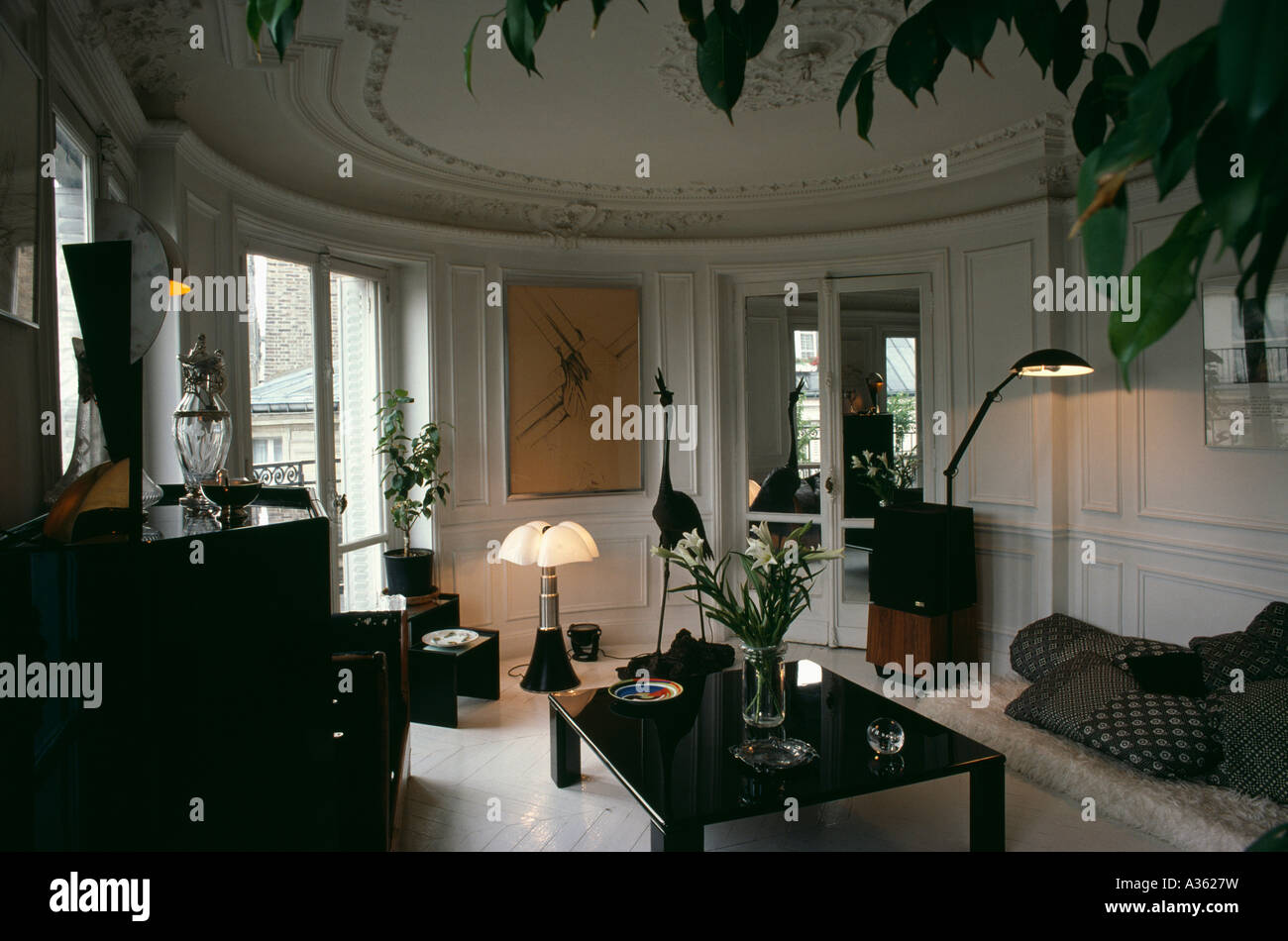 Circular sittingroom with lighted lamp and white walls in apartment ...