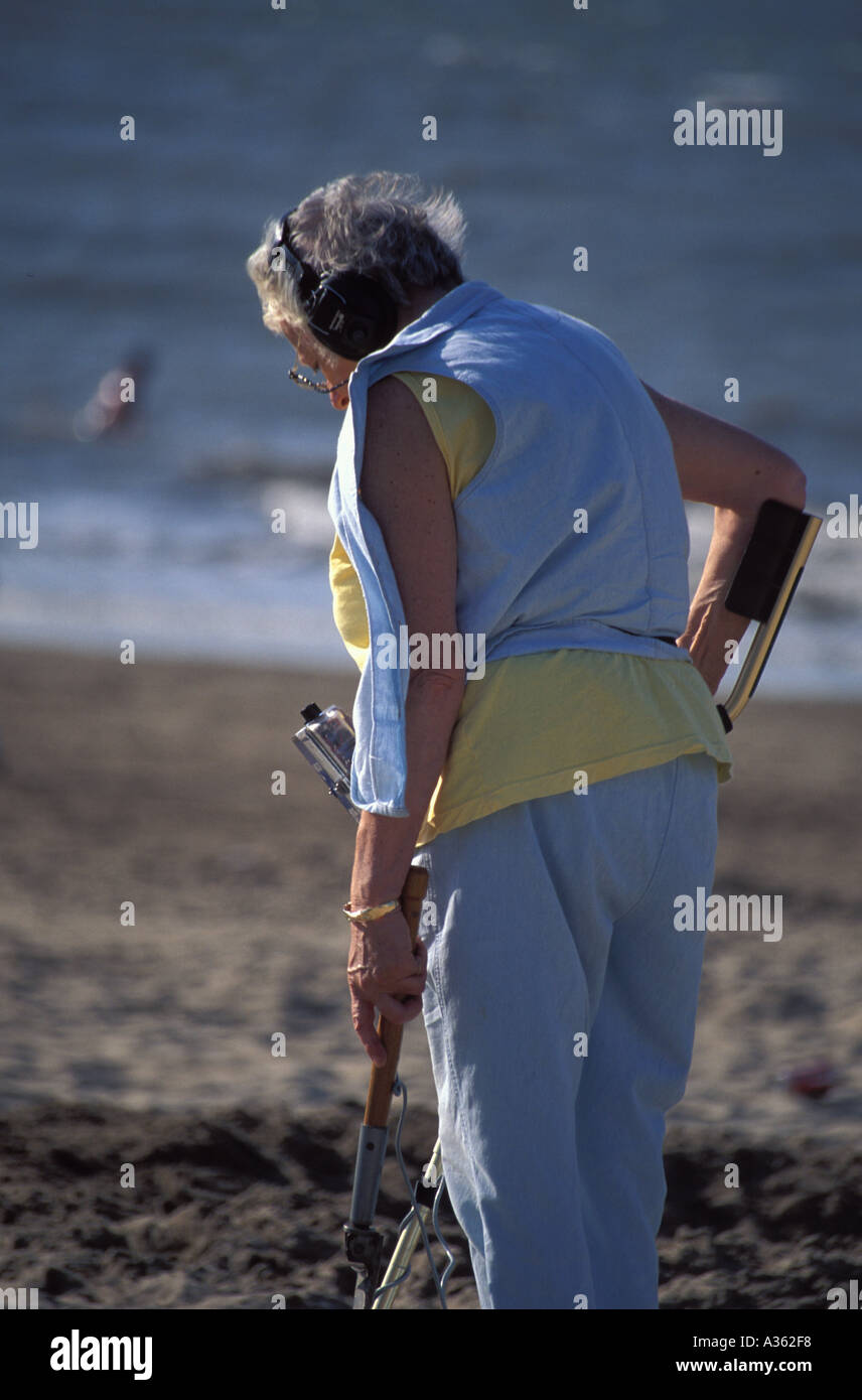 Woman on Beach With Metal Detector Stock Photo - Alamy