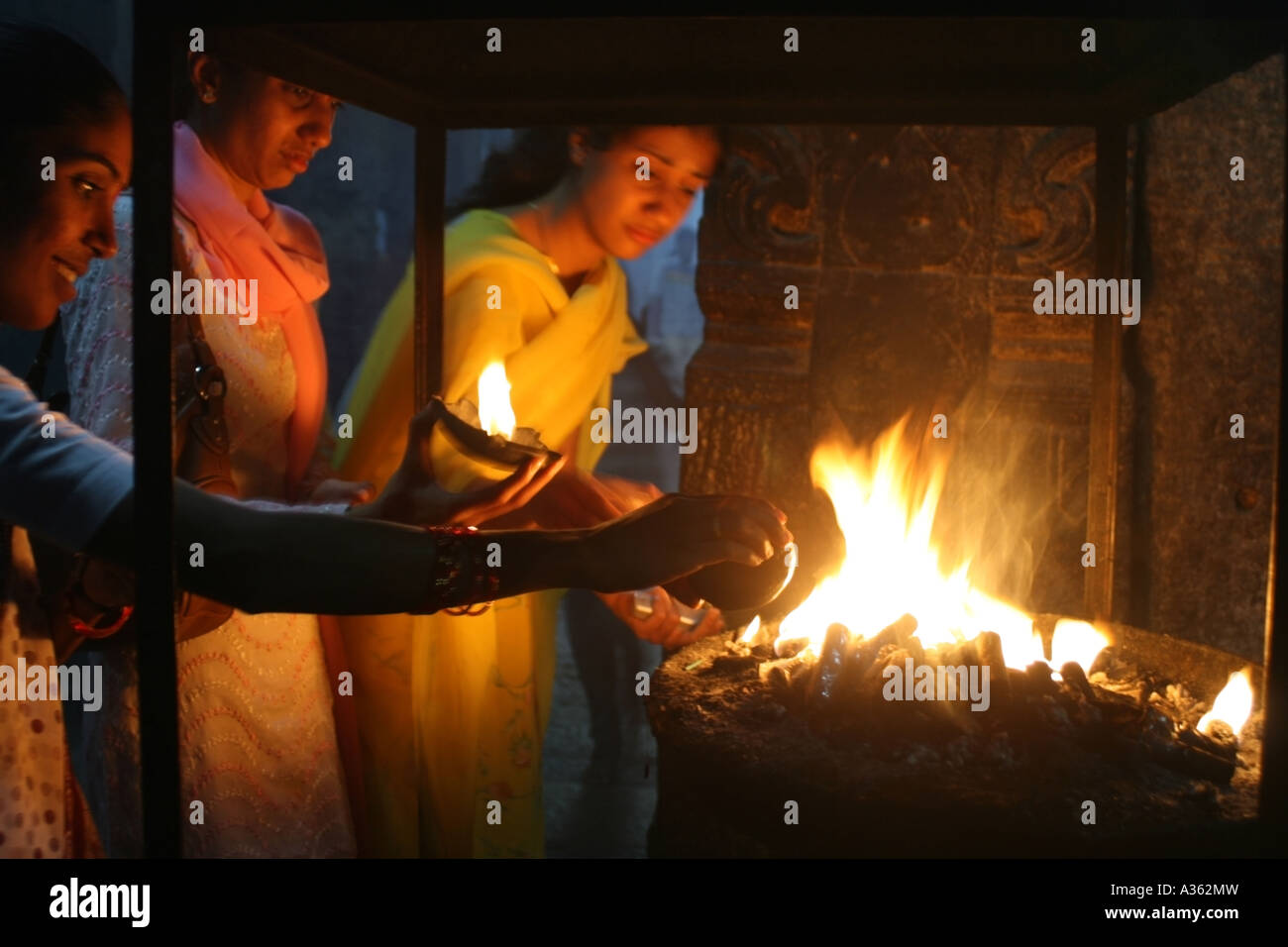 Women offer fire pooja at a shiva temple in India Stock Photo - Alamy