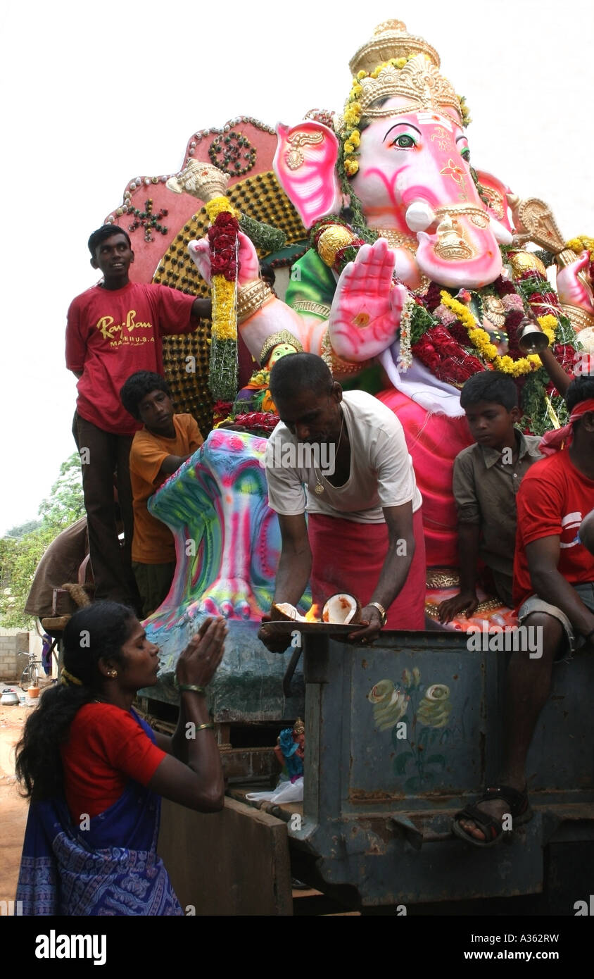 Woman performs pooja to ganesh at a parade for Ganesh Chaturthi , India ...