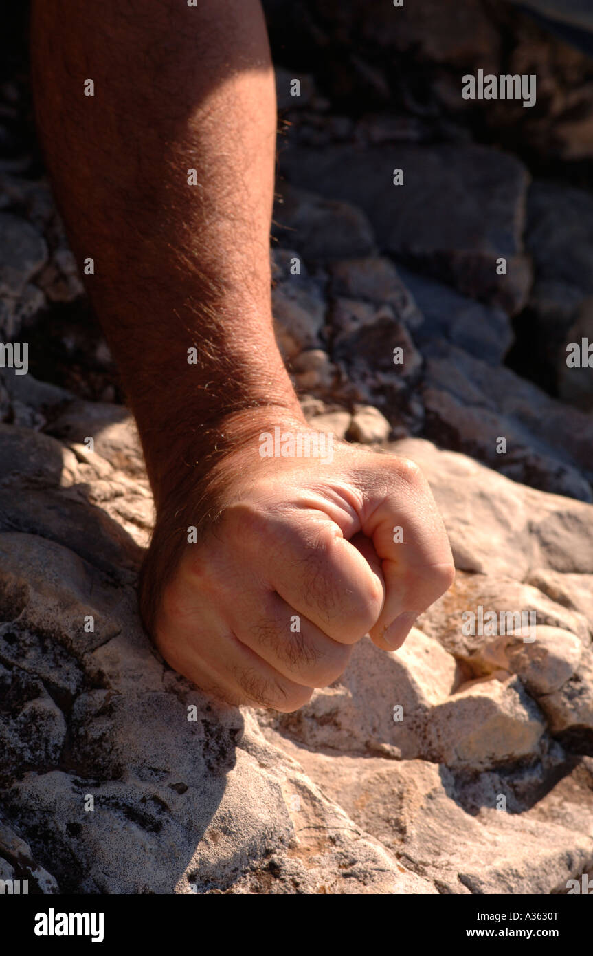 Fist on Rock Stock Photo - Alamy