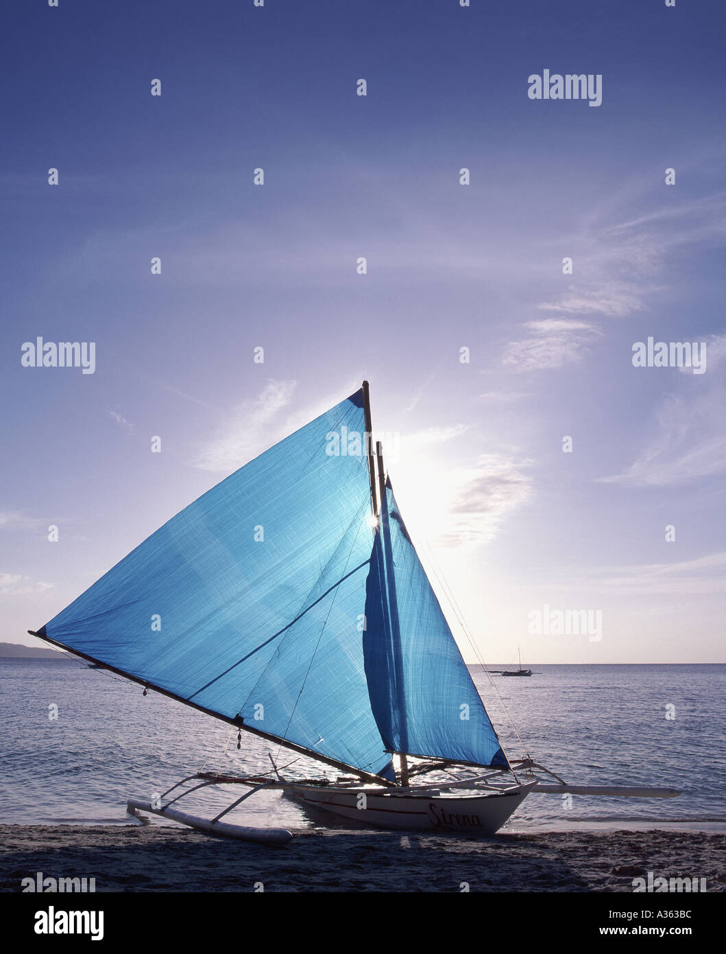 A paraw or sailing outrigger on a beach on Boracay in the Philippines ...