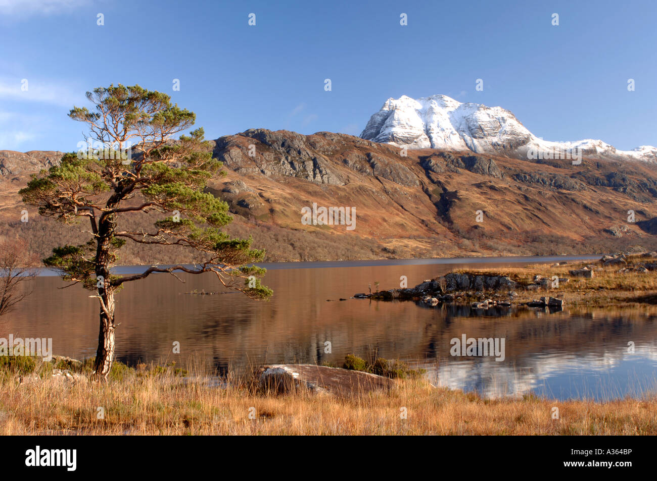 Slioch mountain towers above Loch Maree at Kinlochewe, Wester Ross in ...