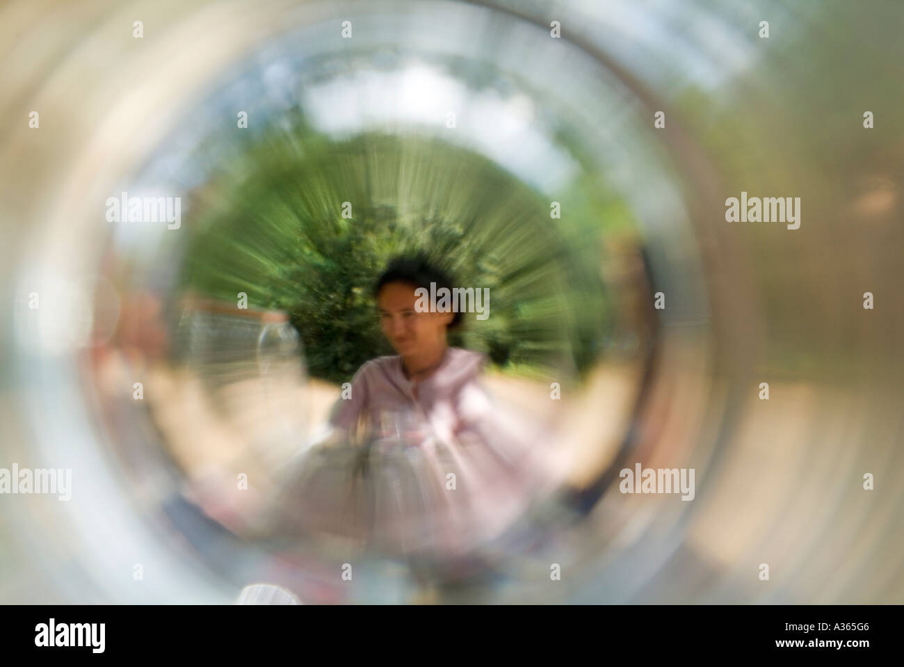 View through the bottom of a glass of a woman Stock Photo - Alamy