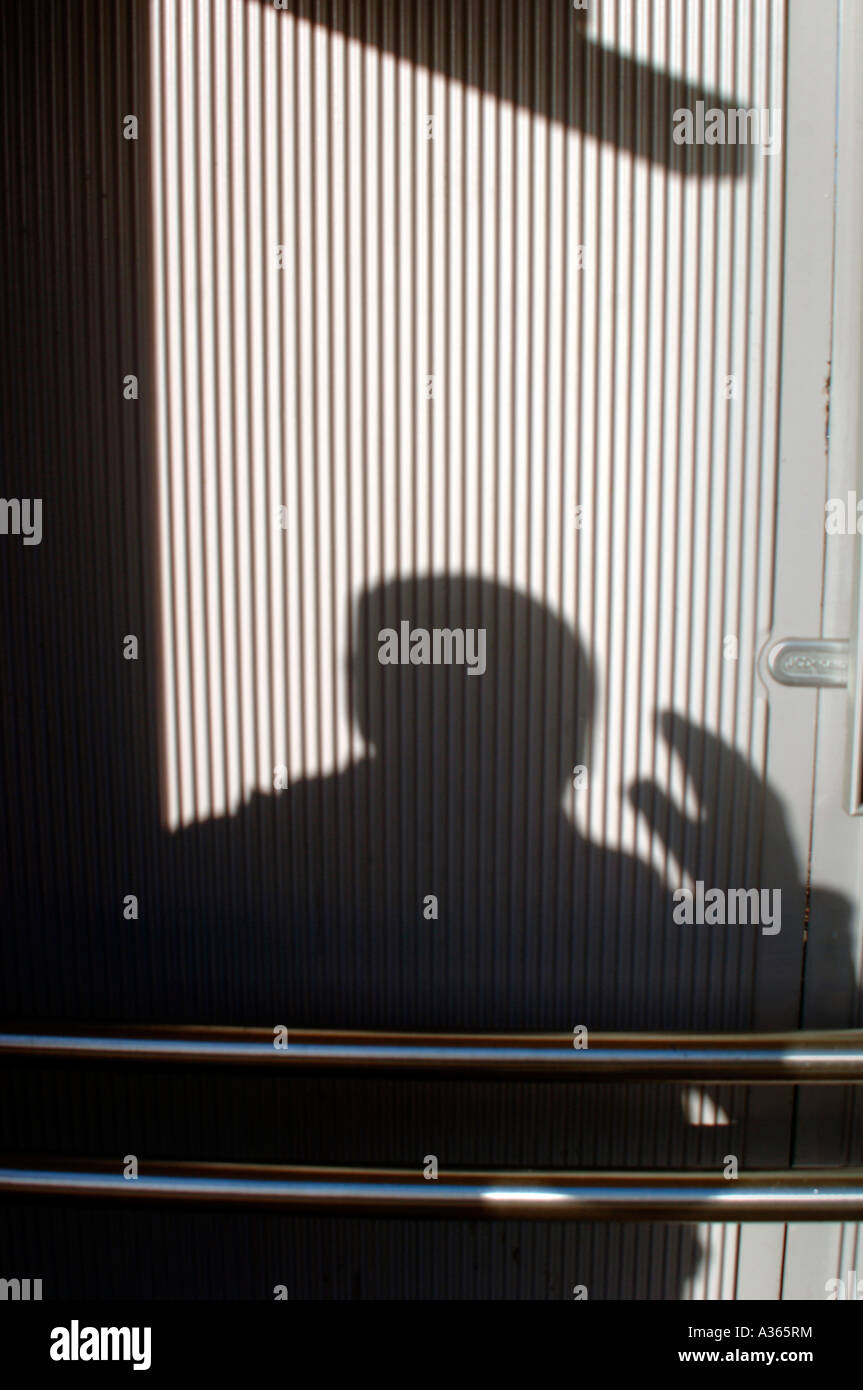 Graphic Shadow Of A Man Waiting At A Bus Stop Stock Photo - Alamy