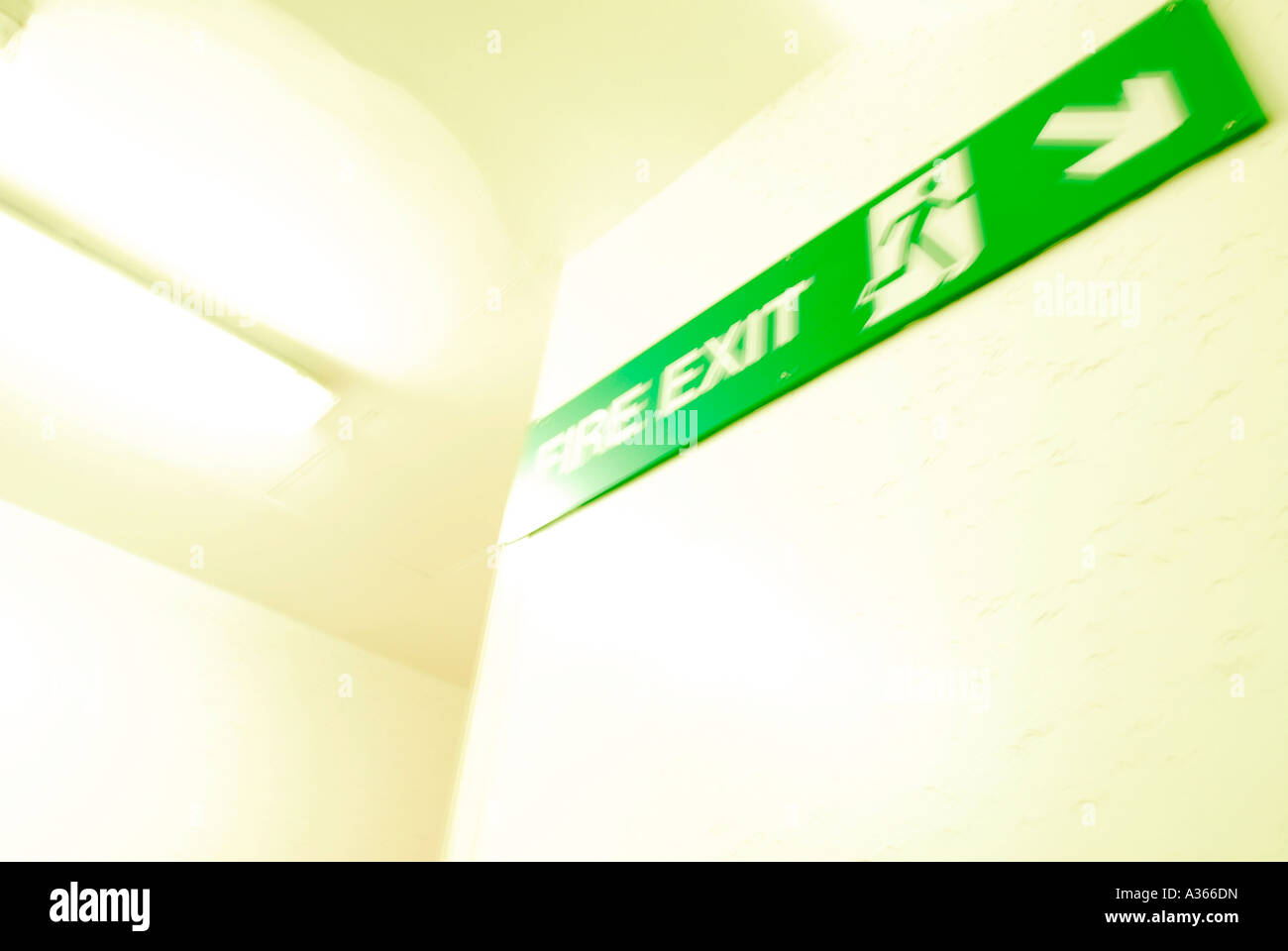 Fire exit sign on internal wall in corridor of building Stock Photo - Alamy