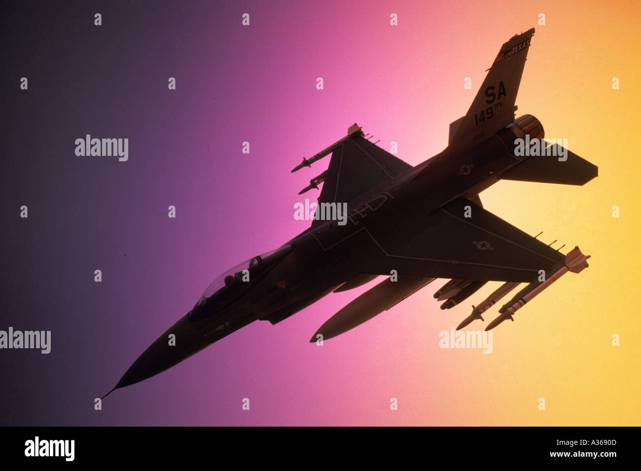 model US Air Force F 16 jet fighter in partial silhoette against blue ...