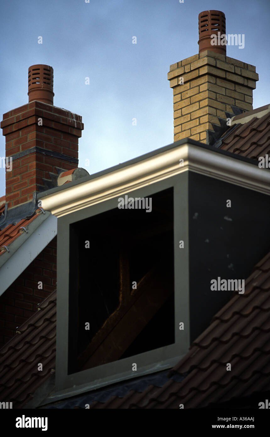 Fibreglass dormer window and plastic replica chimneys on a newly ...