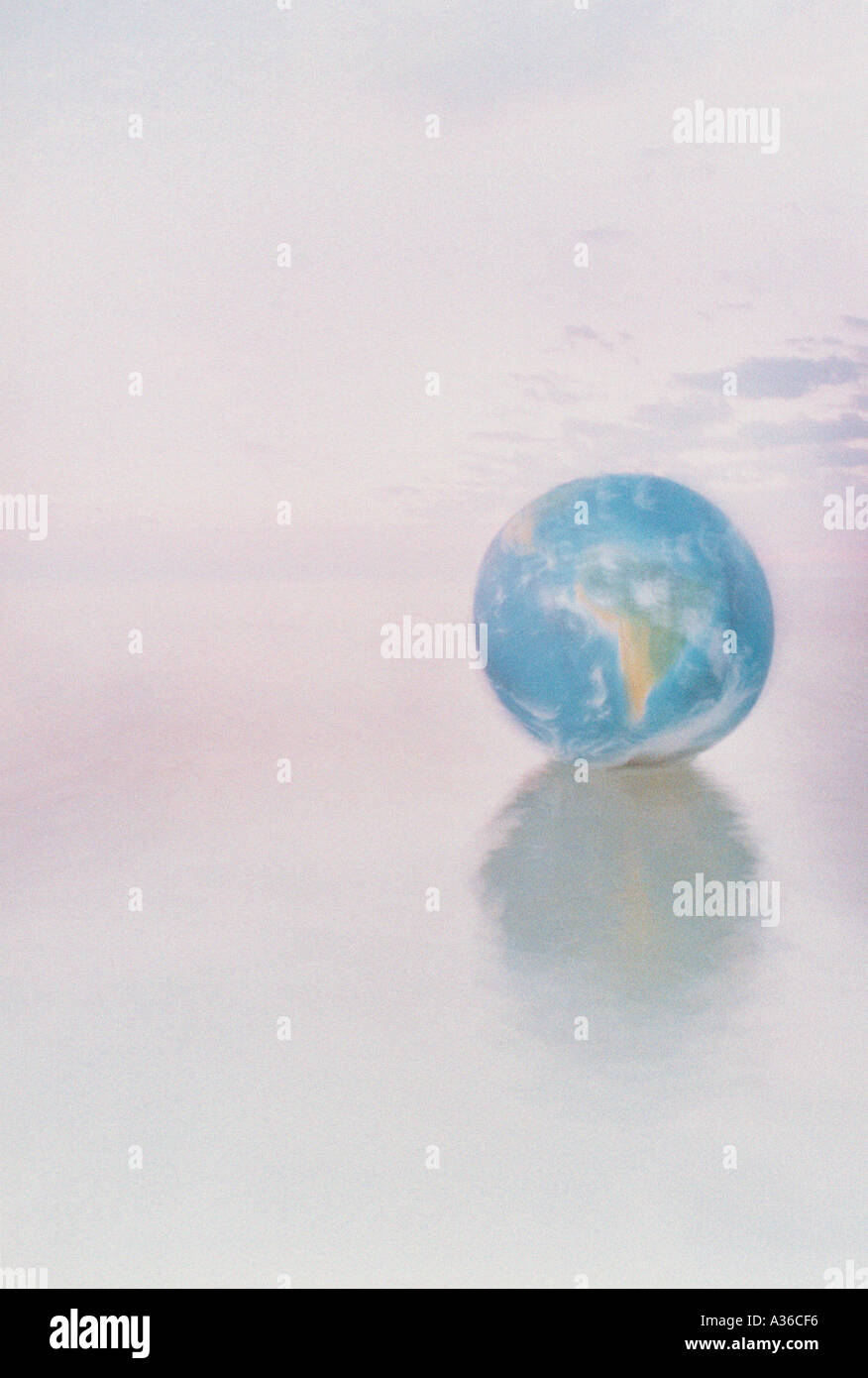 planet earth floating on a lake Stock Photo - Alamy