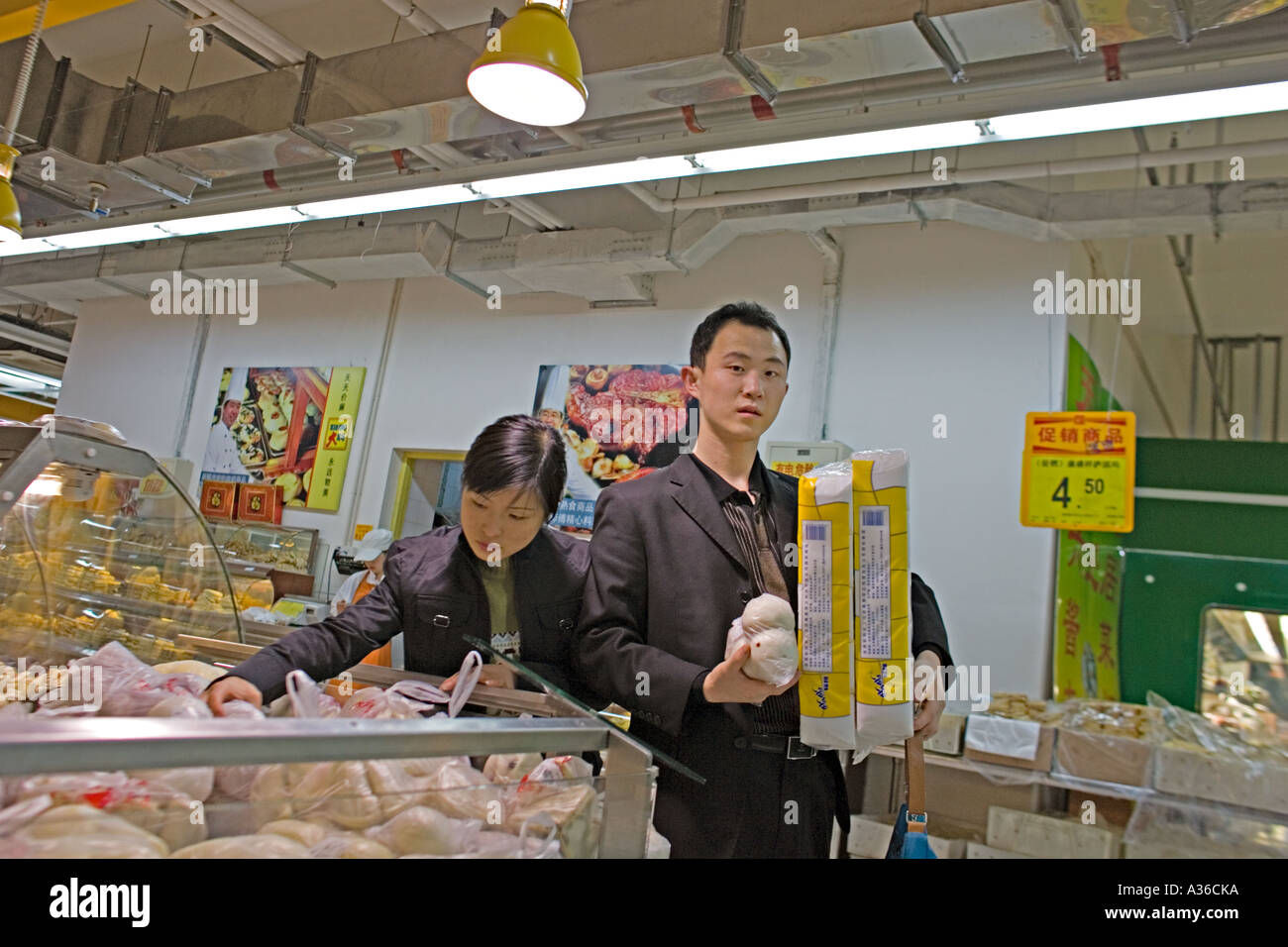 CHINA BEIJING Chinese couple shopping for tofu in Wumart an upscale ...