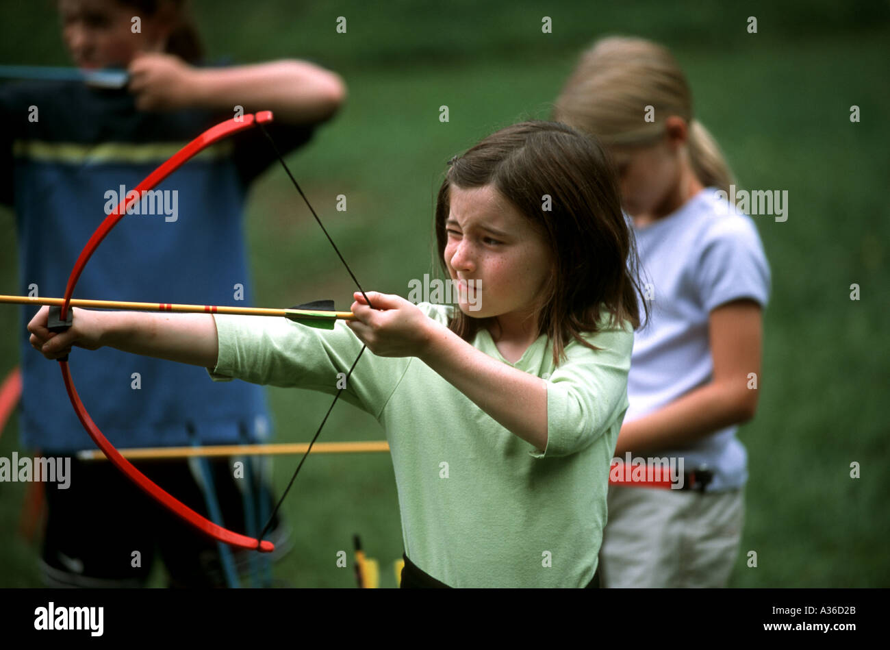 A girl is aiming her bow and arrow Stock Photo - Alamy