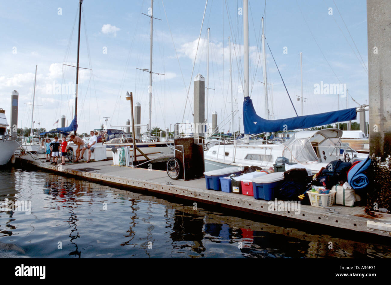 A boat dock in Fernandina is lined with passengers and a stack of ...