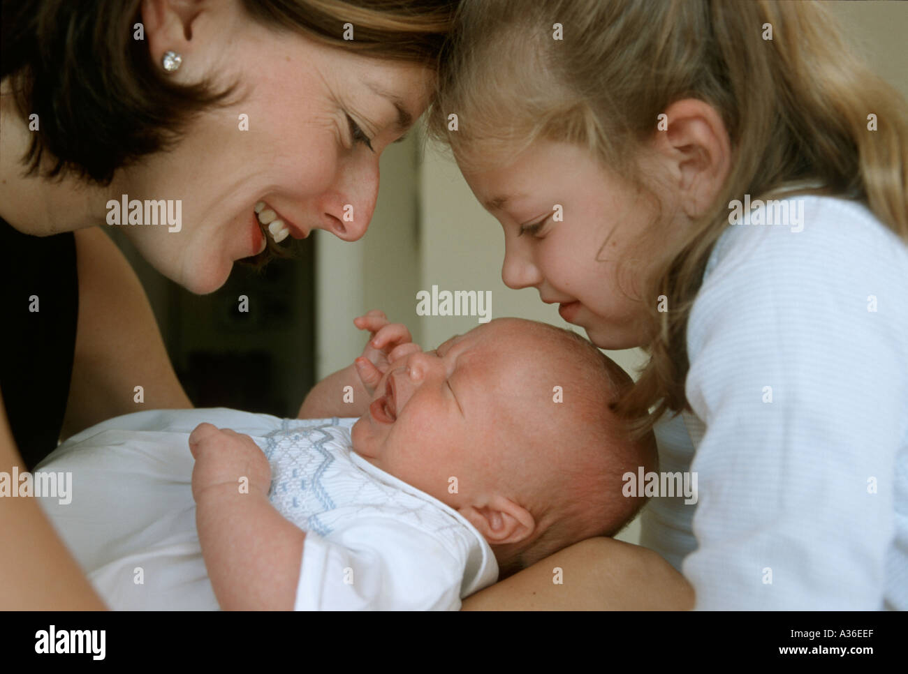 A woman and her young daughter are huddled together looking over their ...