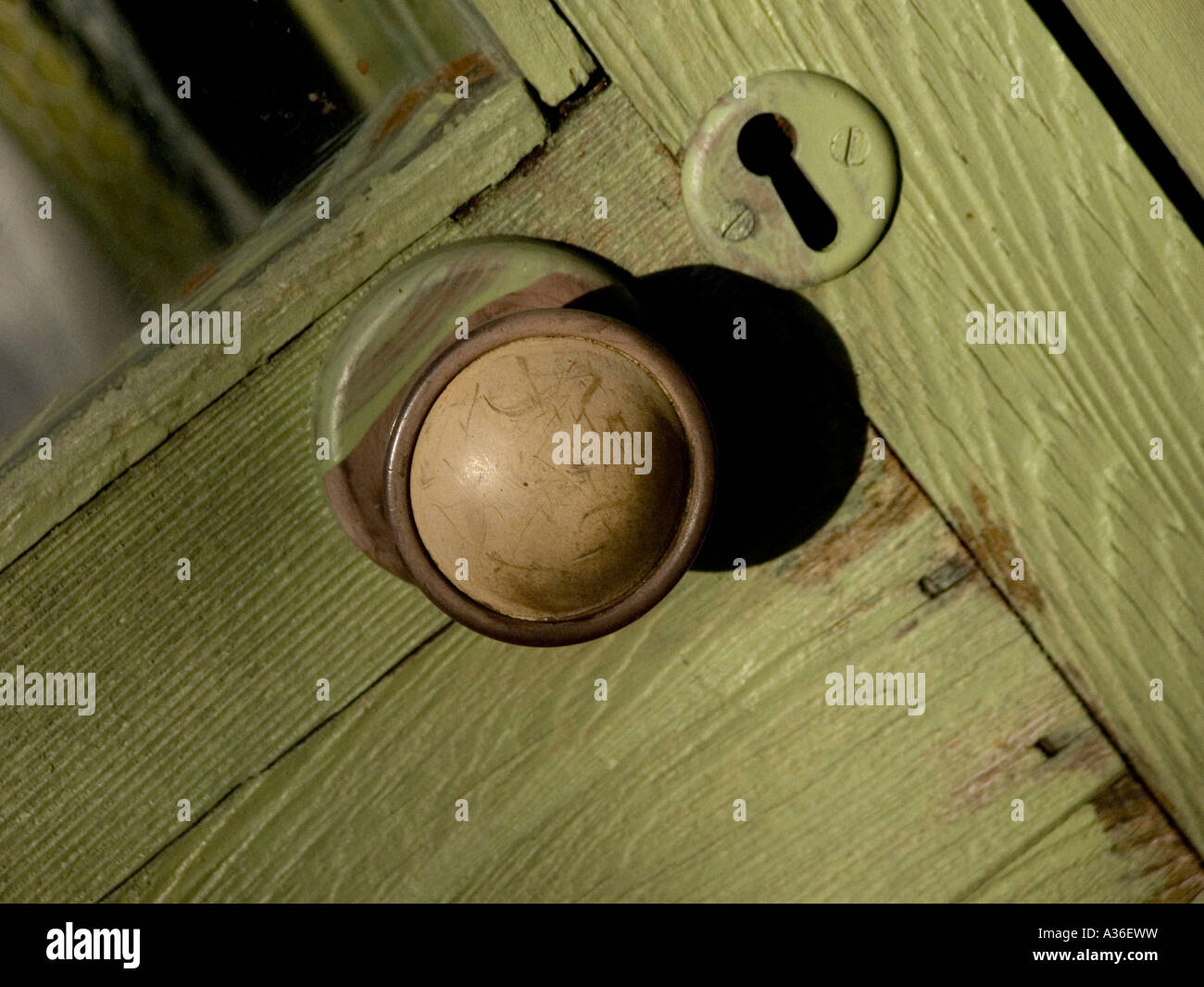 Close-up door knob and keyhole on an old green painted, wooden ...