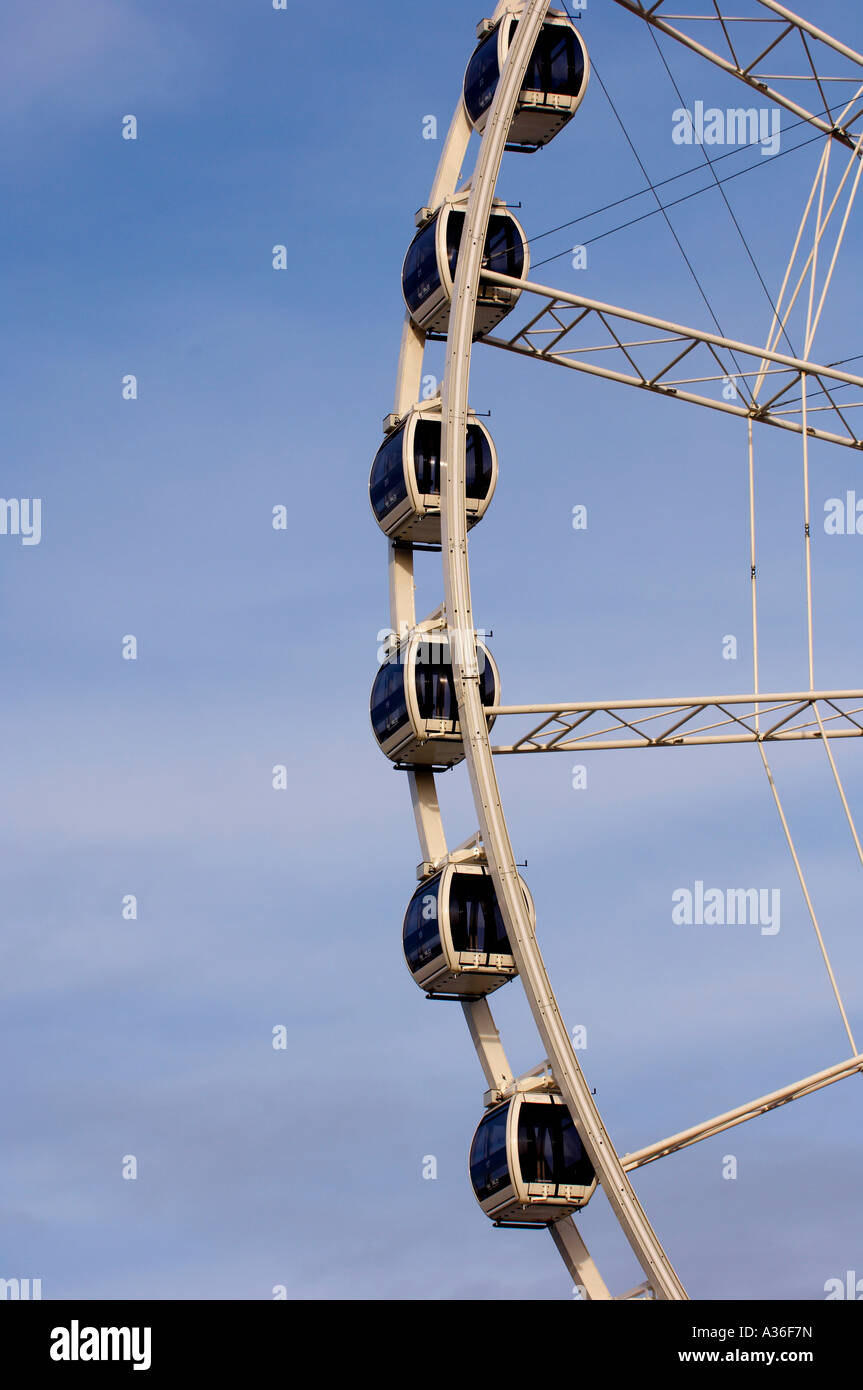 Passenger capsules on an observation wheel seen against a blue sky ...