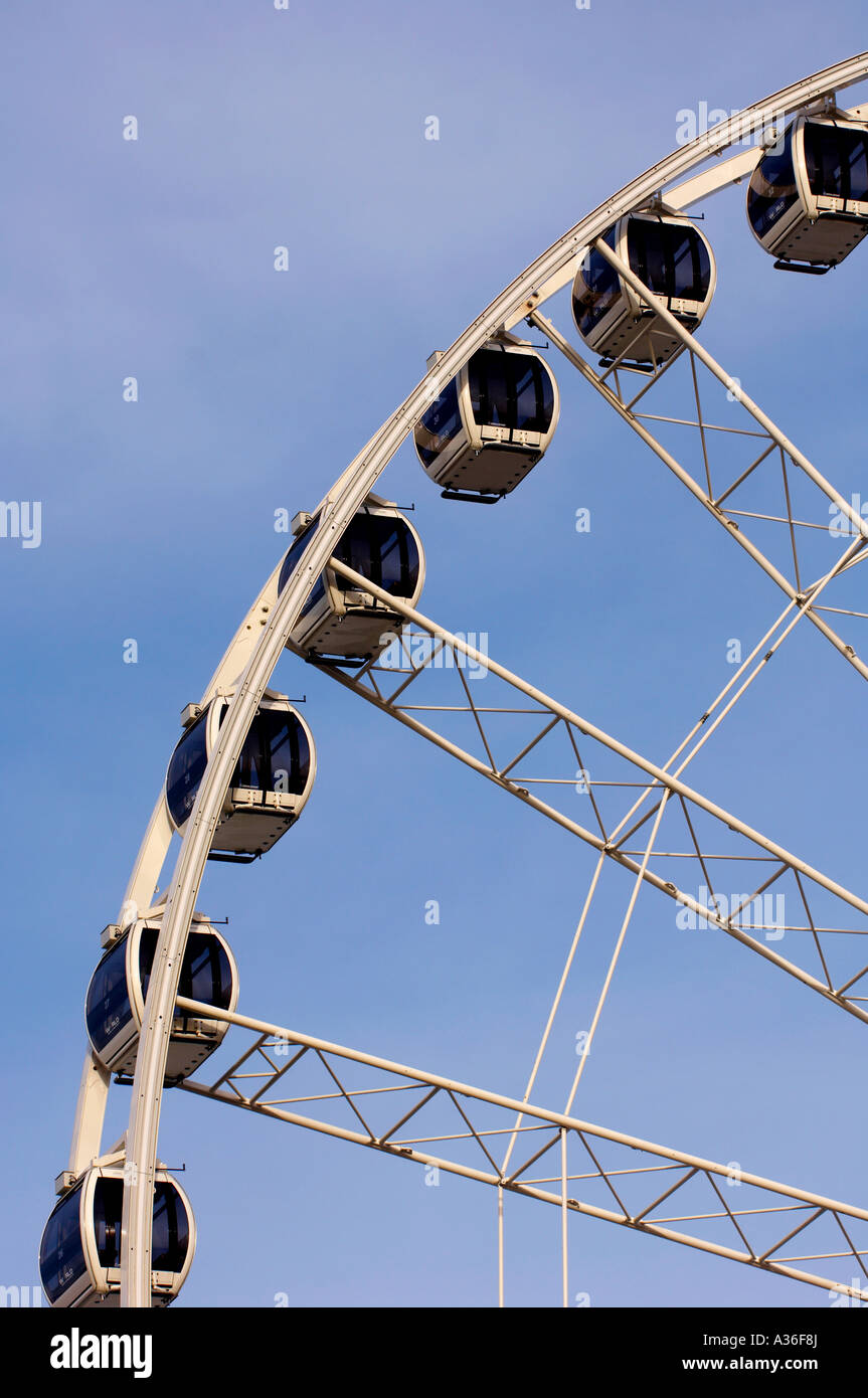 Passenger capsules on an observation wheel seen against a blue sky ...