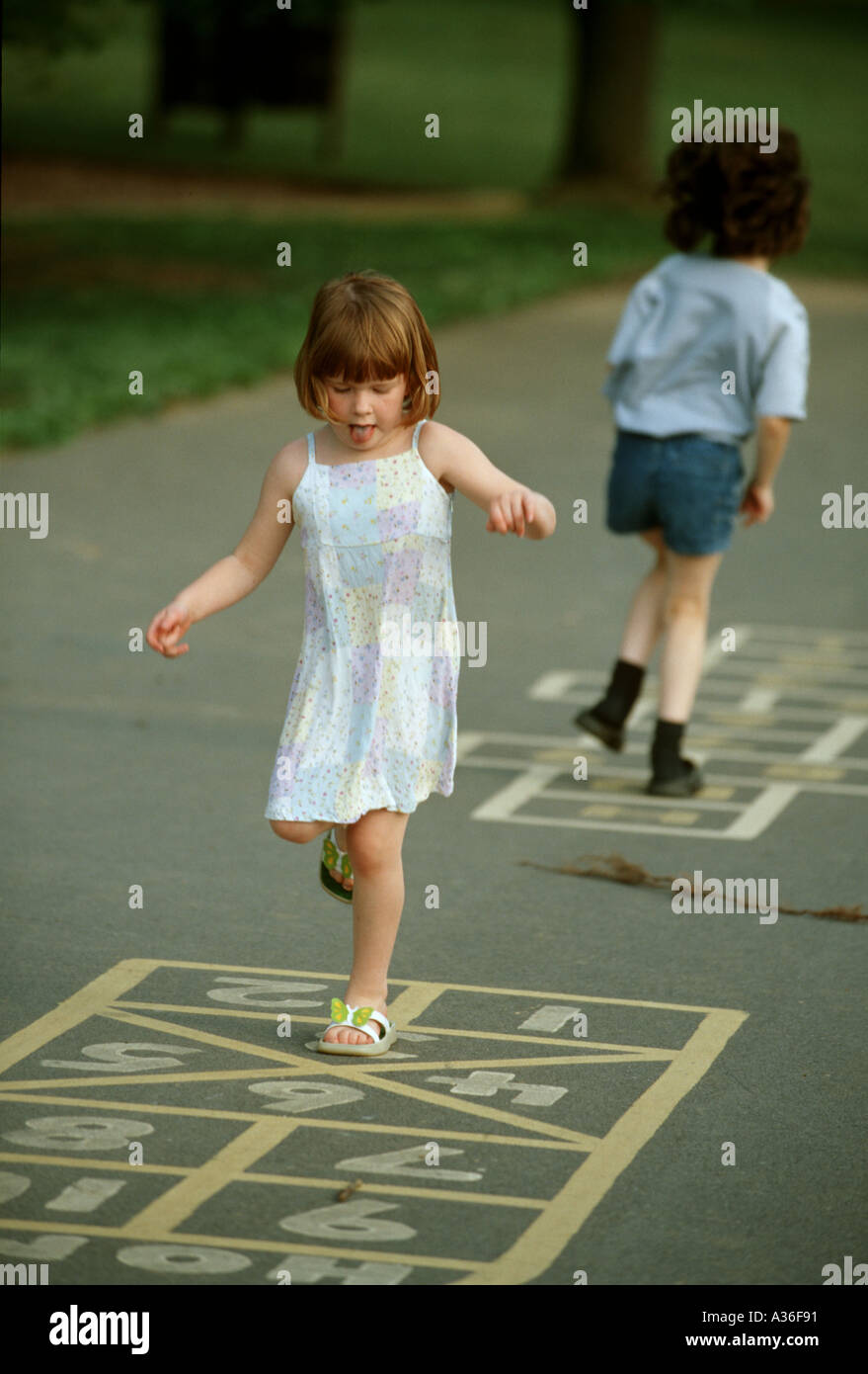 Two girls are playing hopskotch sweetly on a summer day Stock Photo - Alamy