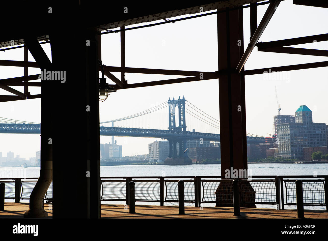 Manhattan bridge between buildings brooklyn hi-res stock photography ...