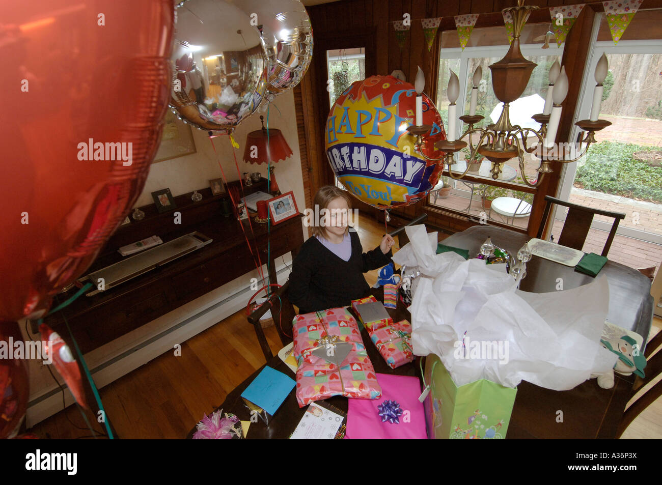 A child enjoys opening her presents on her birthday Stock Photo - Alamy