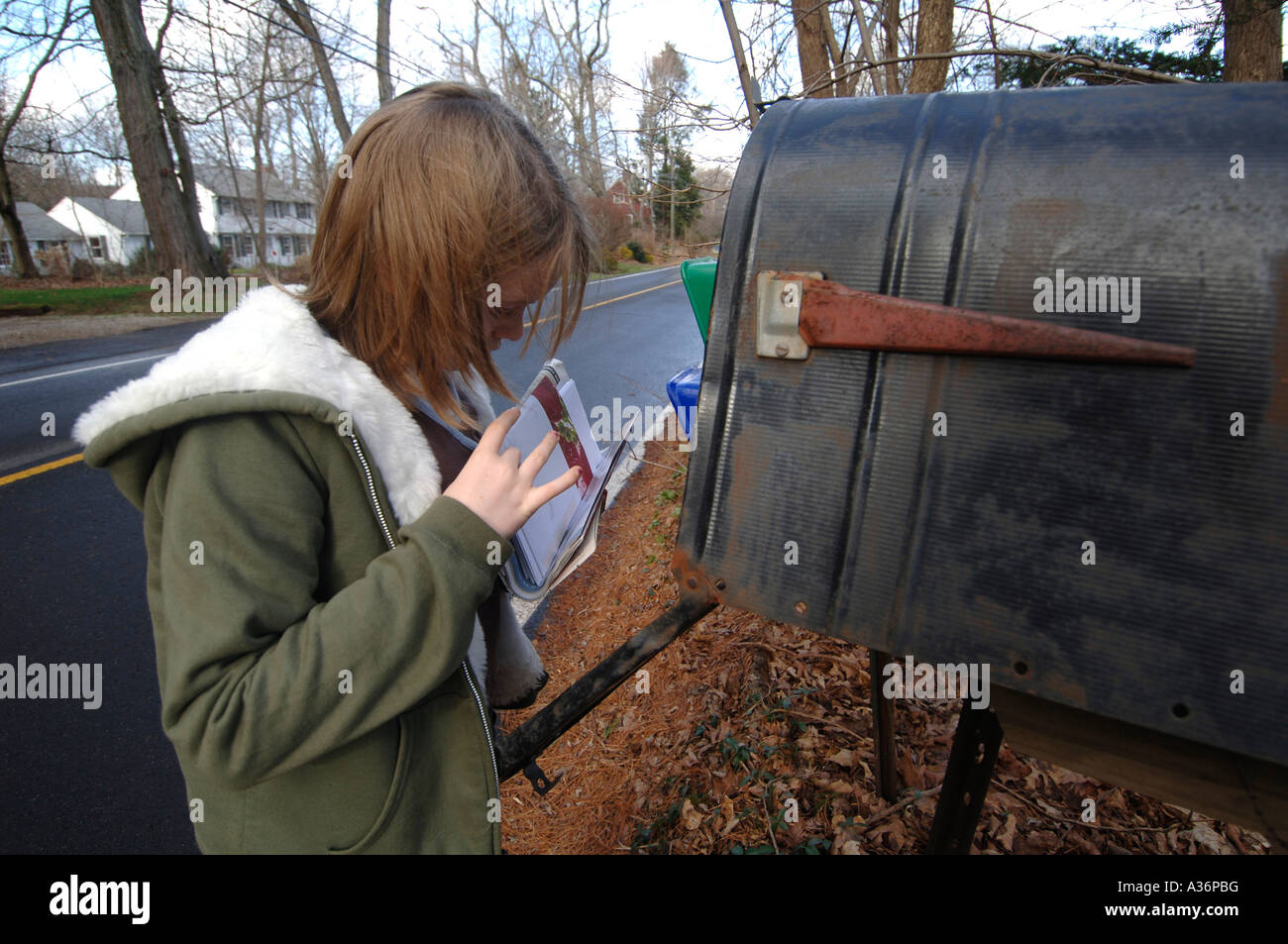 A girl puts mail out in a US post box,where the postman picks up as ...