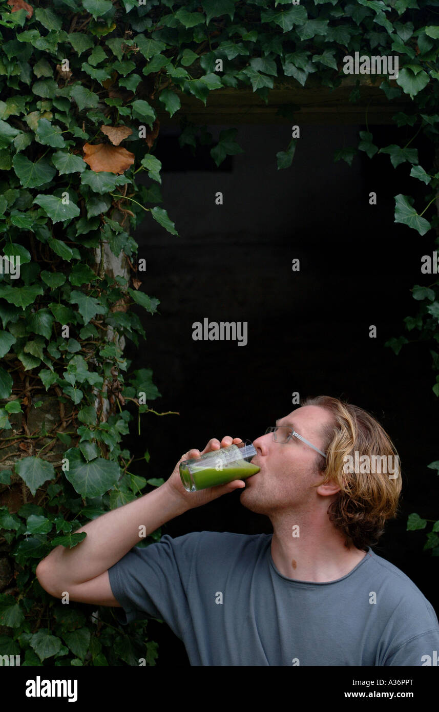a man drinking wheatgrass at a health spa detox weekend Stock Photo - Alamy