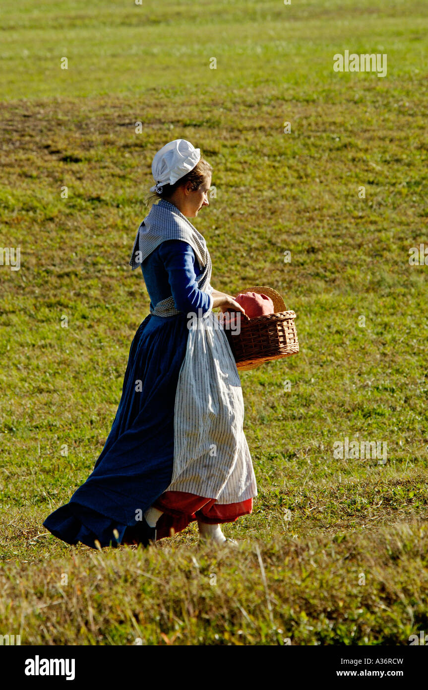 Woman reenactor carrying a basket at a Yorktown Battlefield reenactment ...