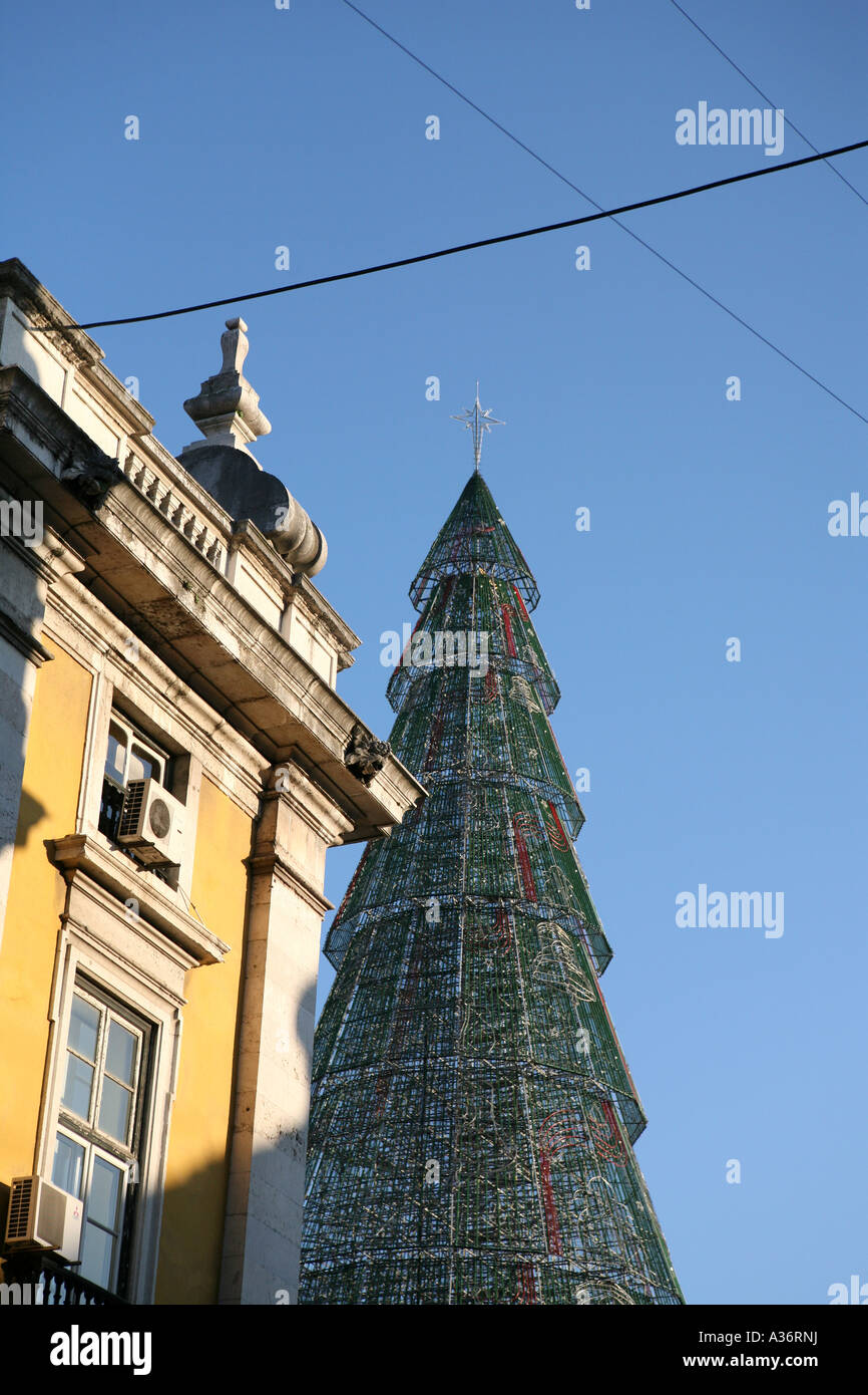 A giant christmas tree in lisbon city center next to a traditional ...