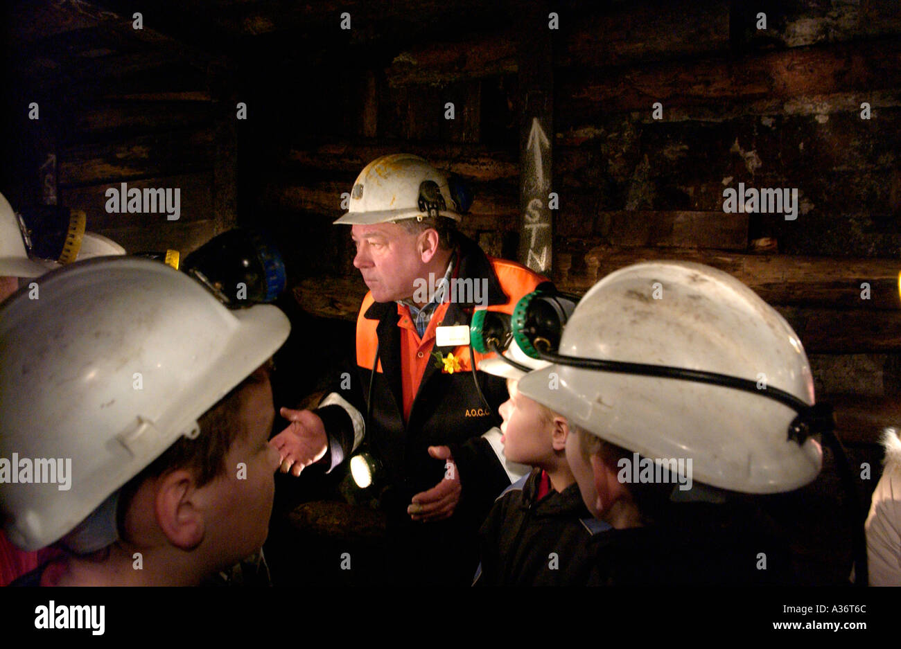 Guide a former miner giving school pupils an underground tour at Big ...