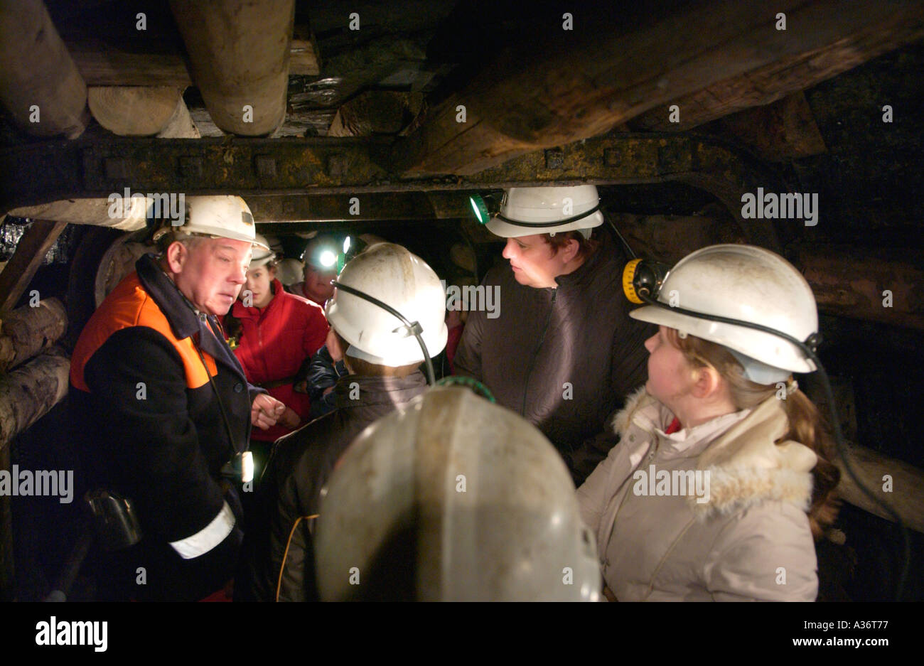Guide a former miner giving school pupils an underground tour at Big ...