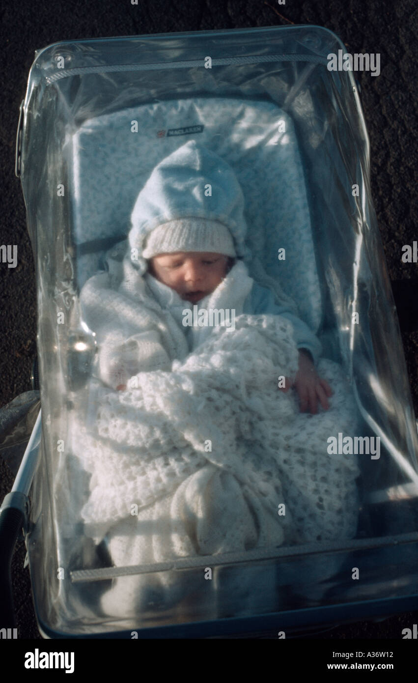 Baby well wrapped up and safe in a pushchair Stock Photo - Alamy