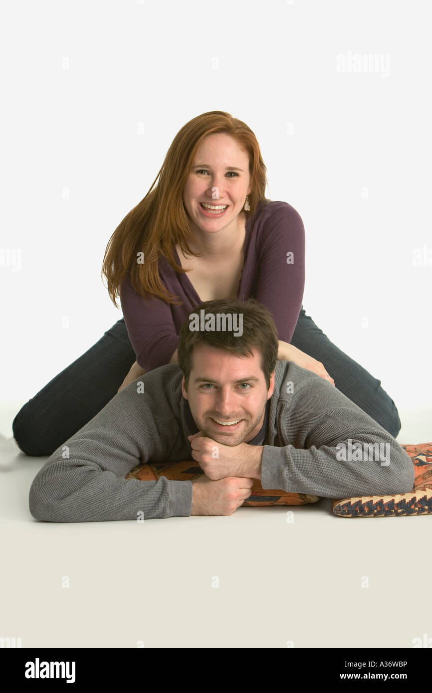 Two young lovers smiling at the camera Stock Photo - Alamy