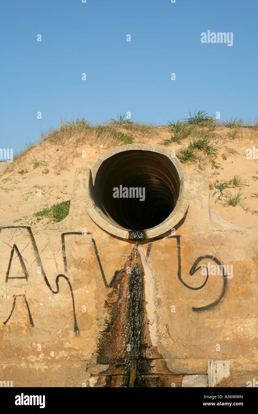 A sewage outlet on a beach on the algarve, portugal Stock Photo - Alamy