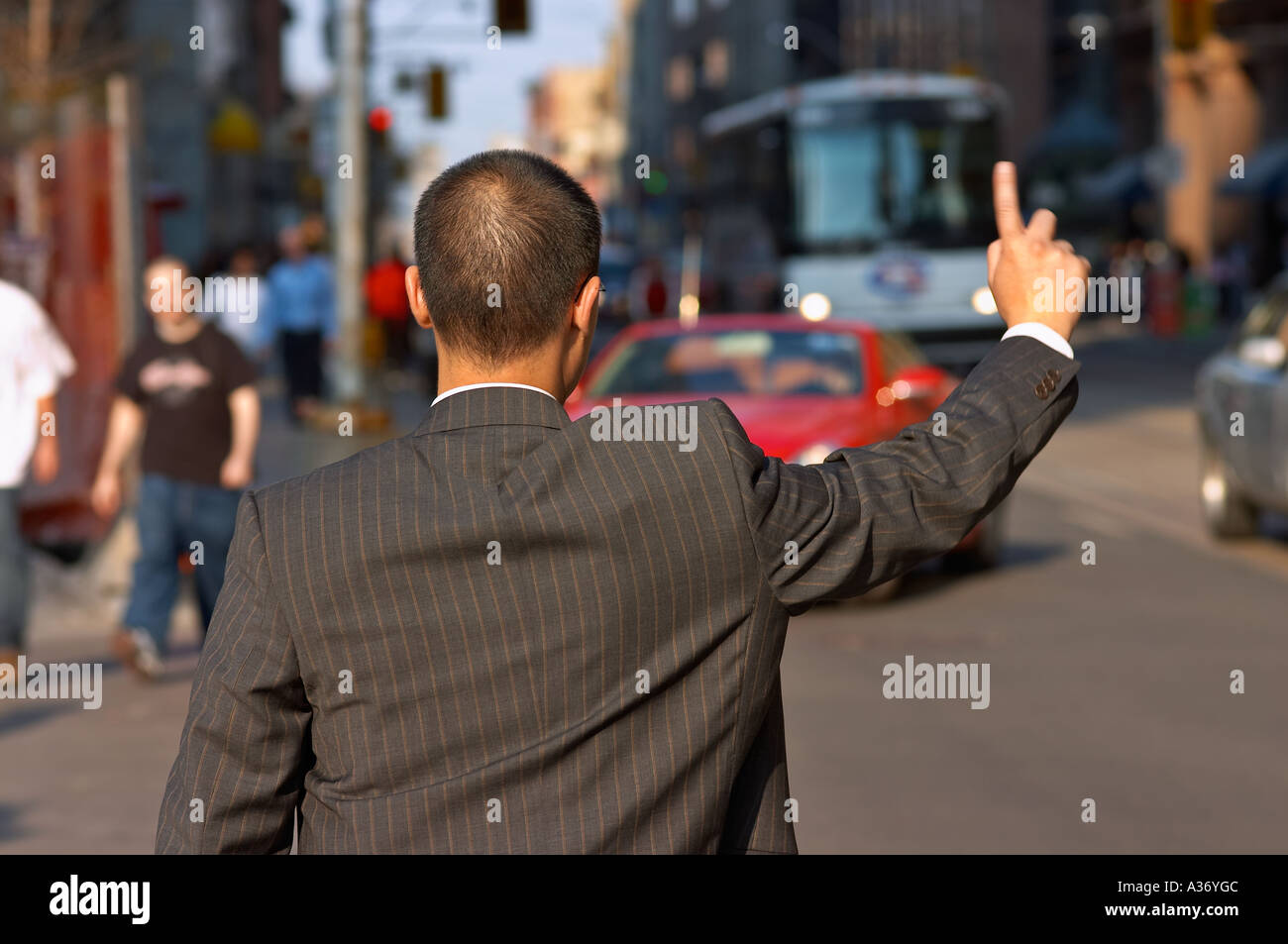 Man dressed in suit is hailing a cab Stock Photo - Alamy