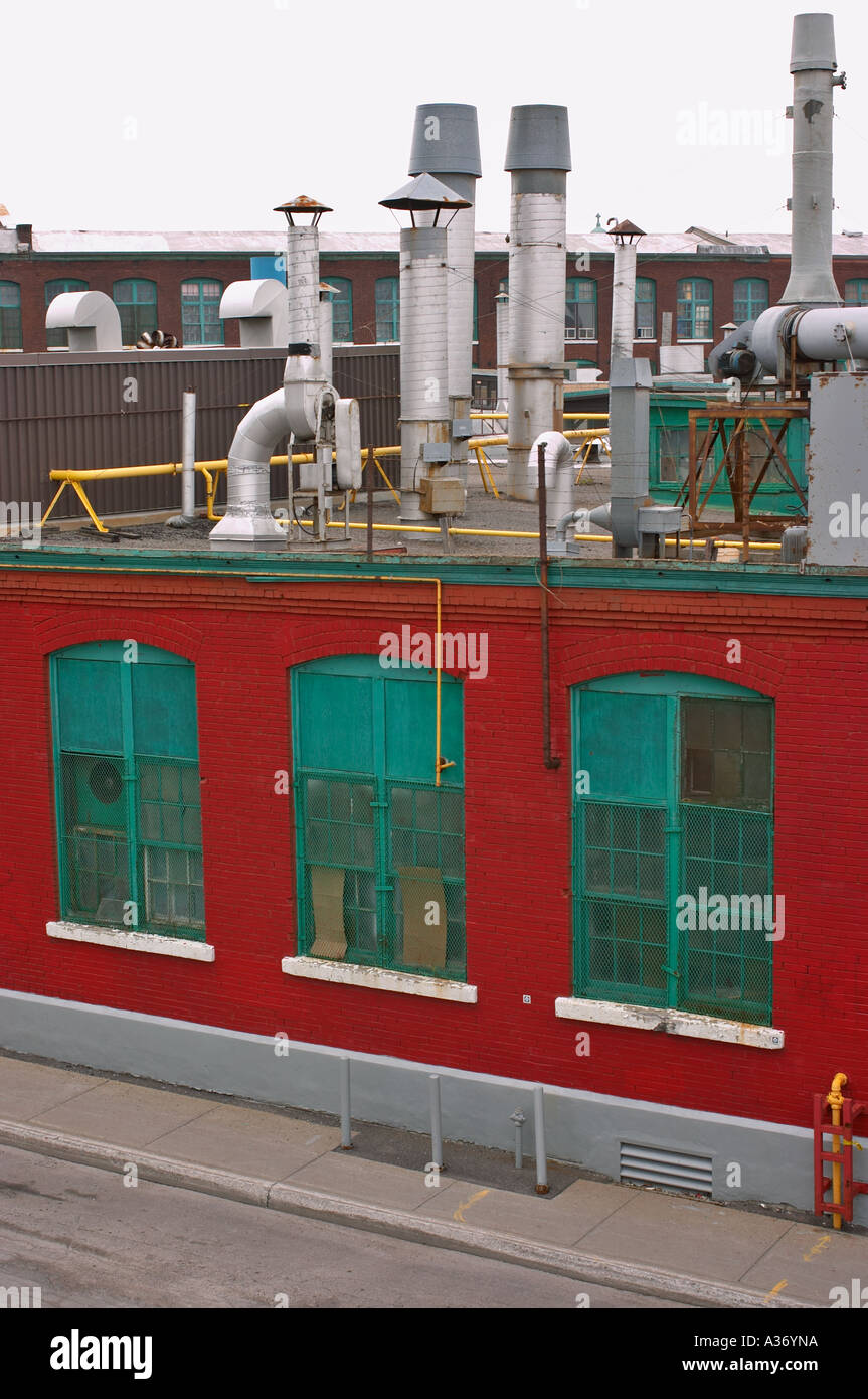 Brightly painted manufacturing plant / factory in a poorer area of ...