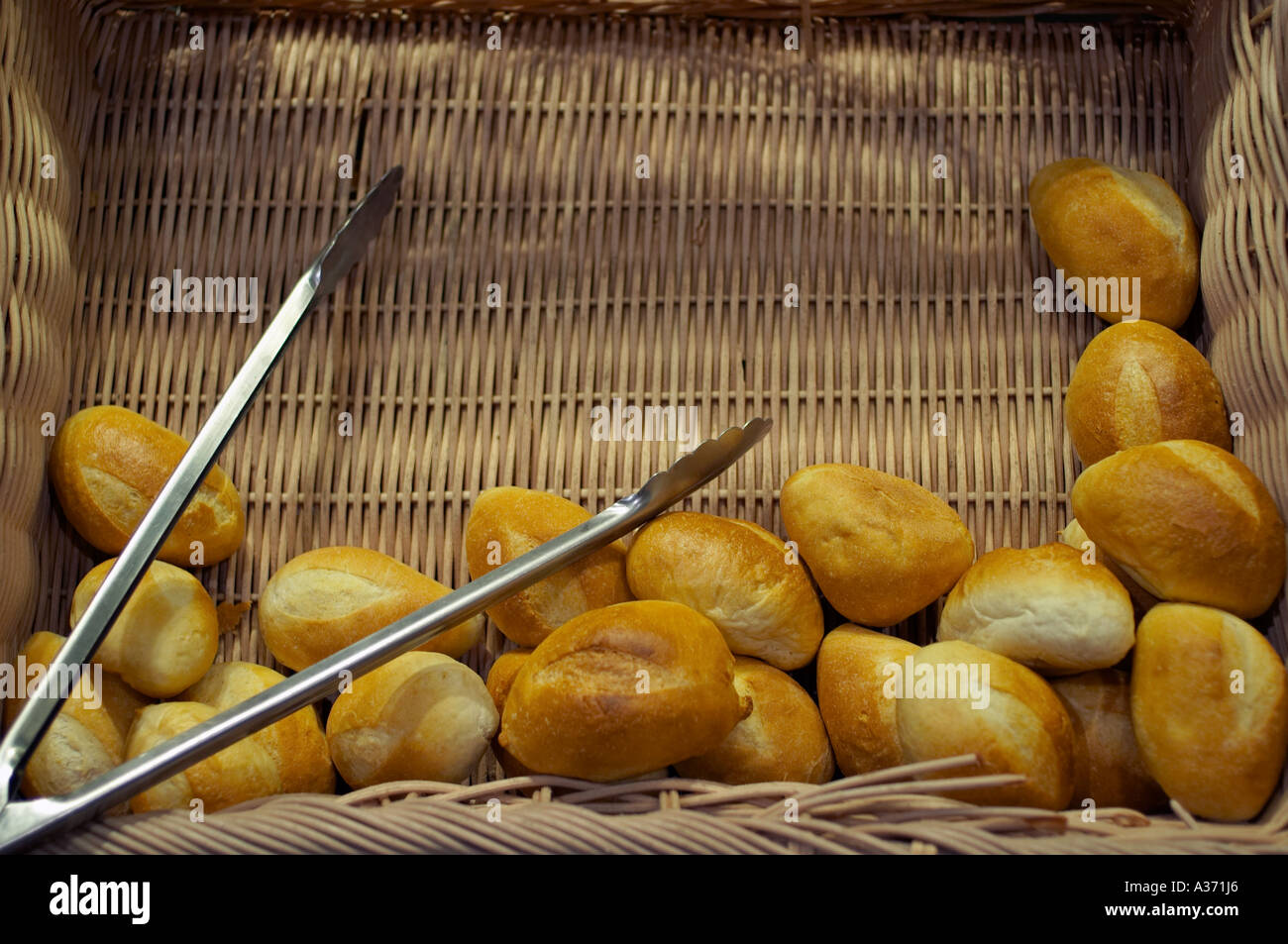 Half-empty bakery bread basket with steel tongs Stock Photo - Alamy