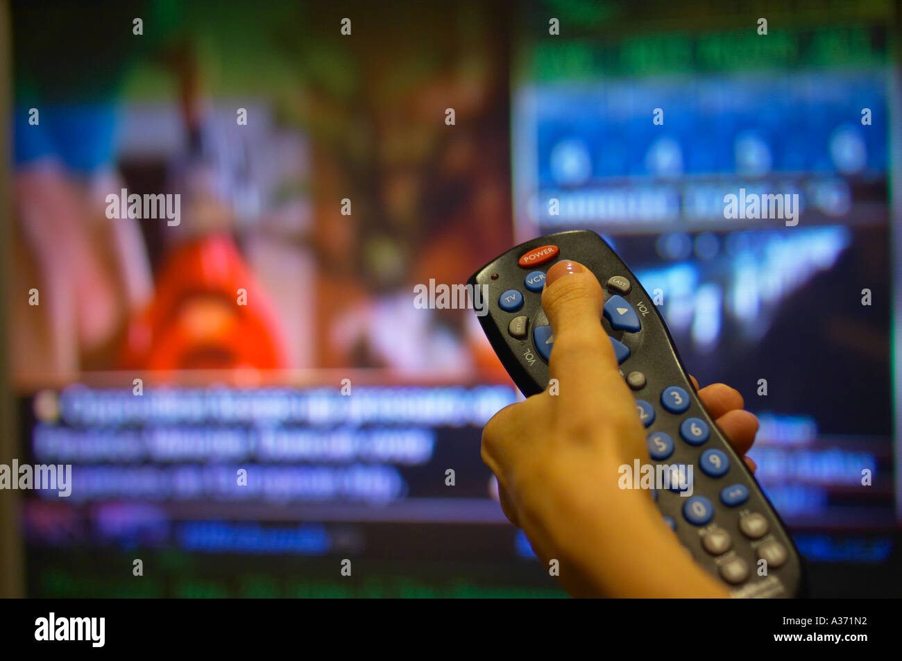 Woman's hand on remote control, surfing channels. Watching TV - news ...