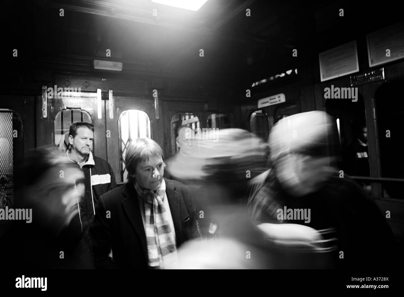 A woman waiting in a busy lift Stock Photo - Alamy