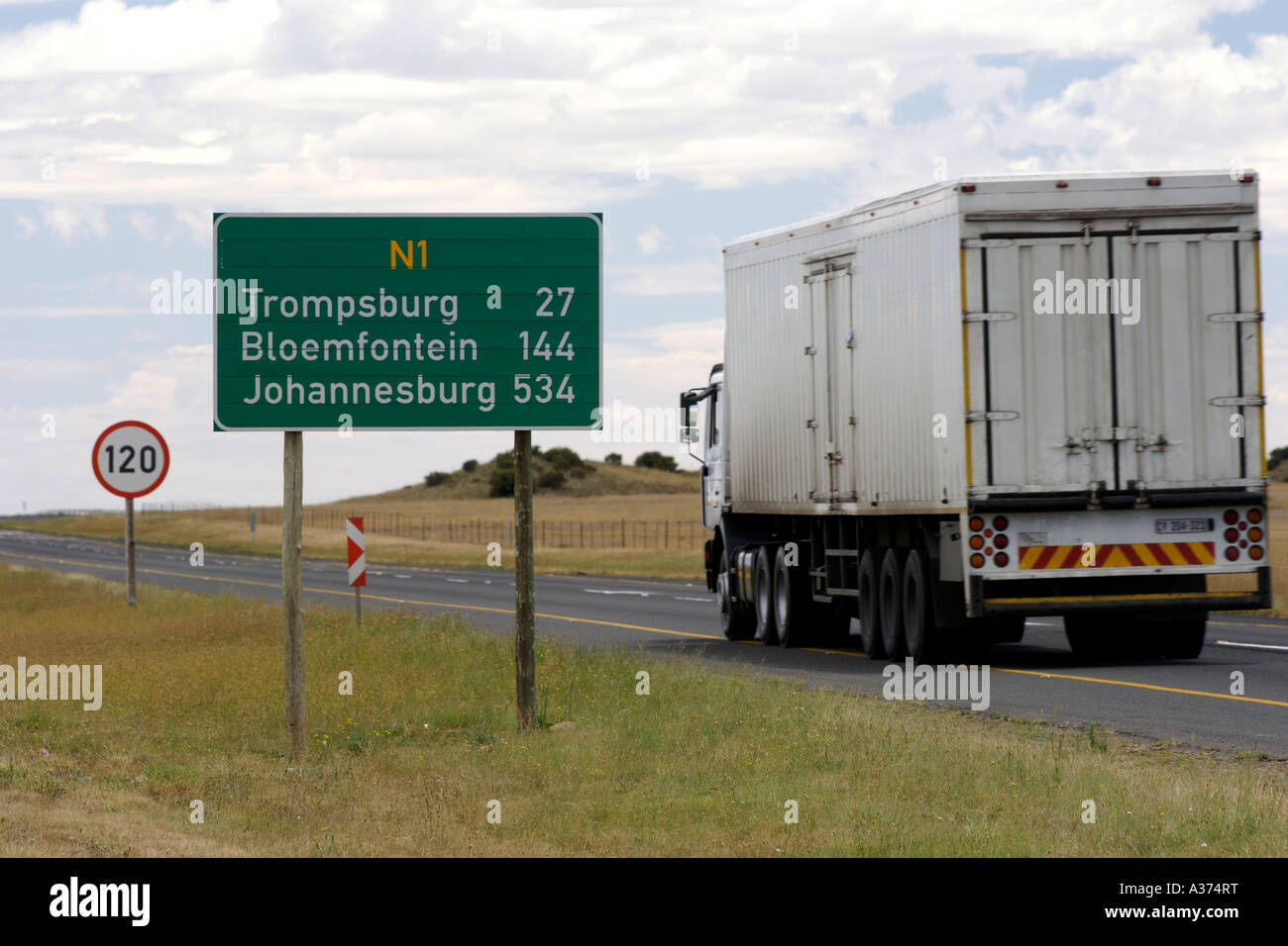 Distance sign board and a passing truck along the N1 highway in South ...