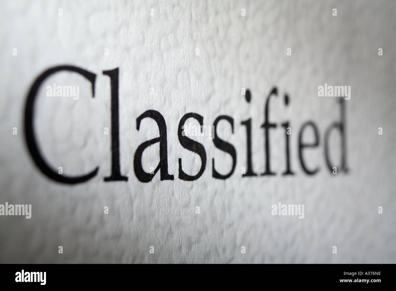 the word classified printed on to texture paper Stock Photo - Alamy