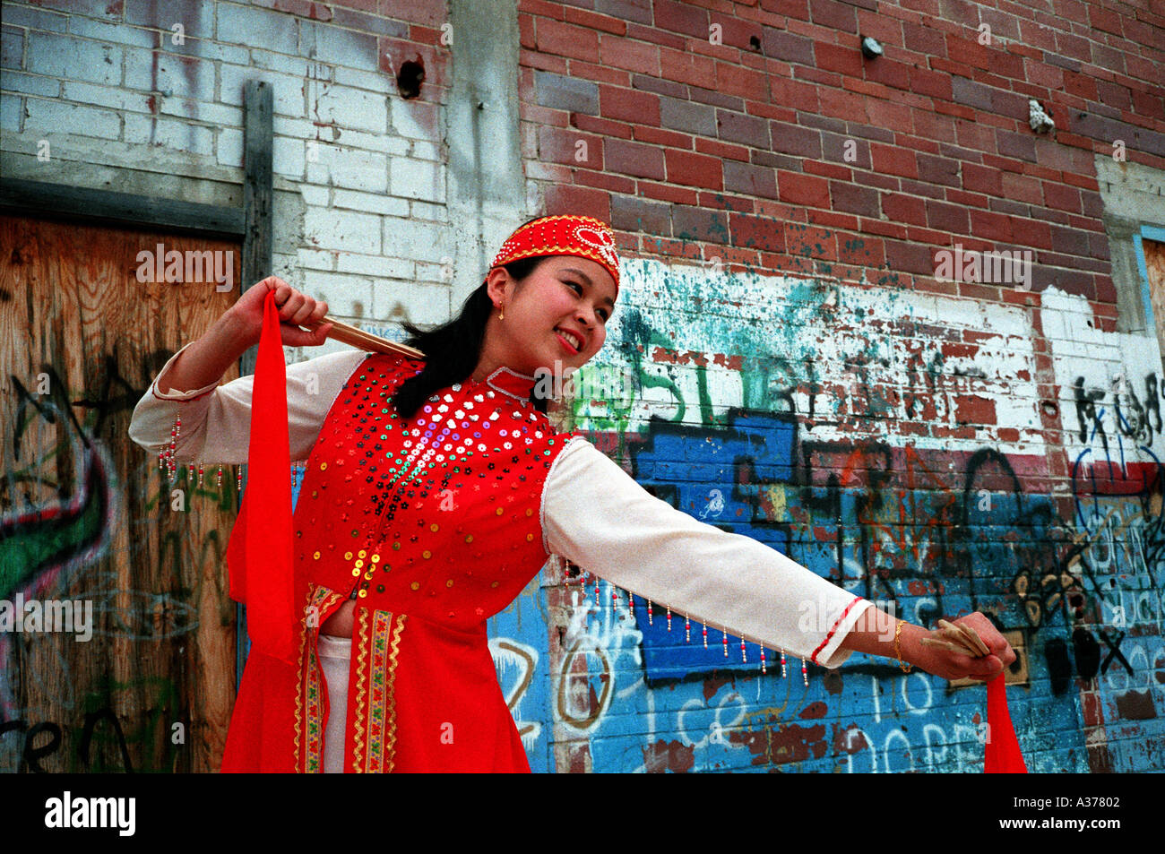 chinese chop stick dance by Chinese girl in red costume and scarf Stock ...