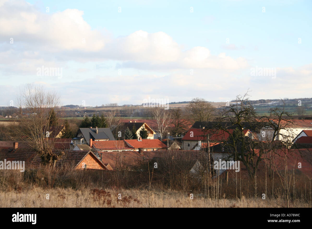 Rural landscape with a cluster of houses under a cloudy sky Stock Photo ...