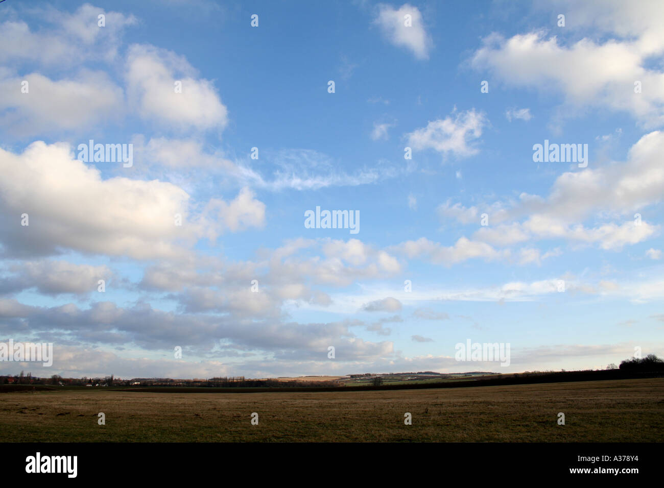 Expansive cloudy sky over an open field at daylight Stock Photo - Alamy