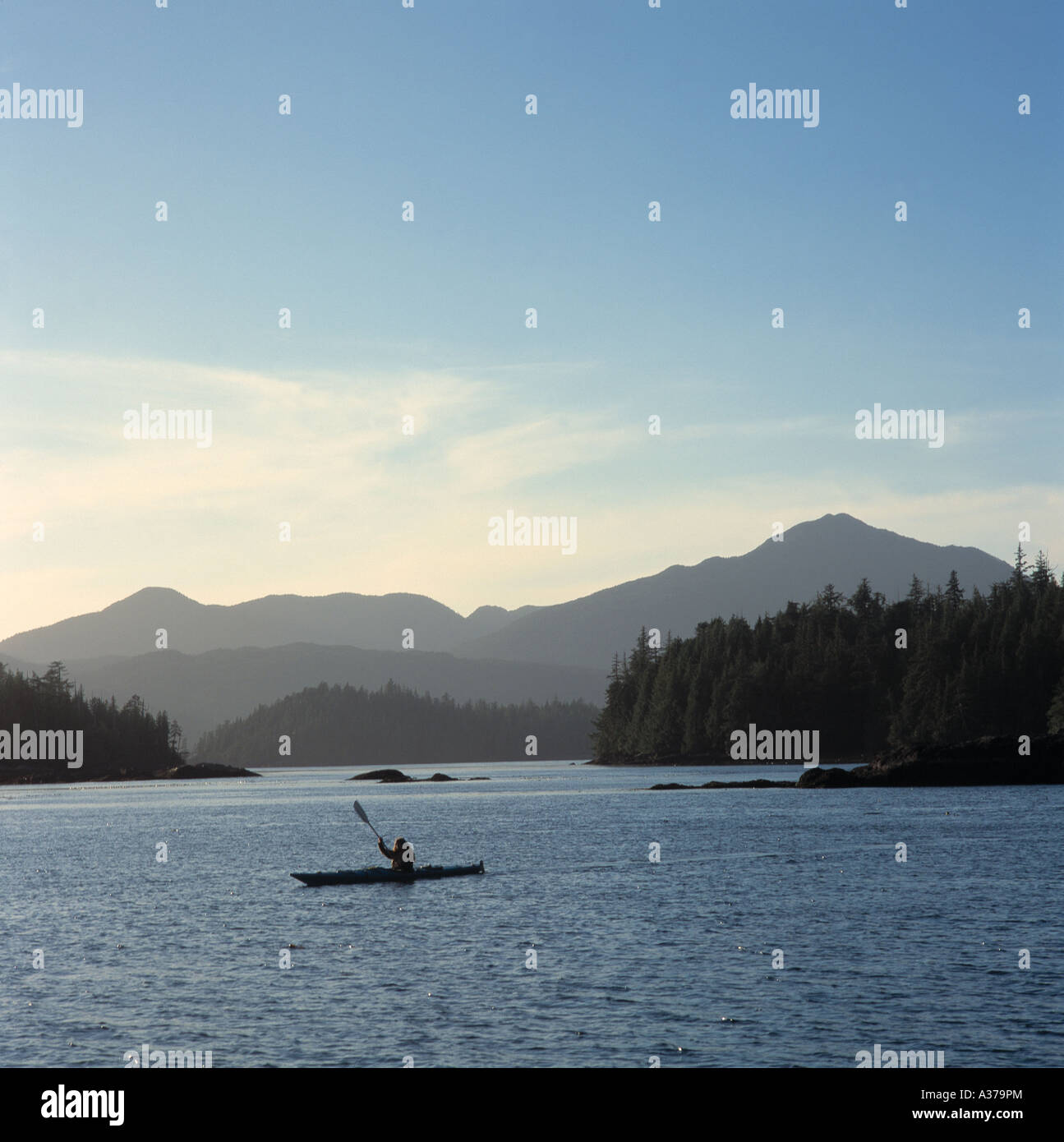 Canoeist at Rose Inlet looking towards Kunghit Island , Queen Charlotte ...